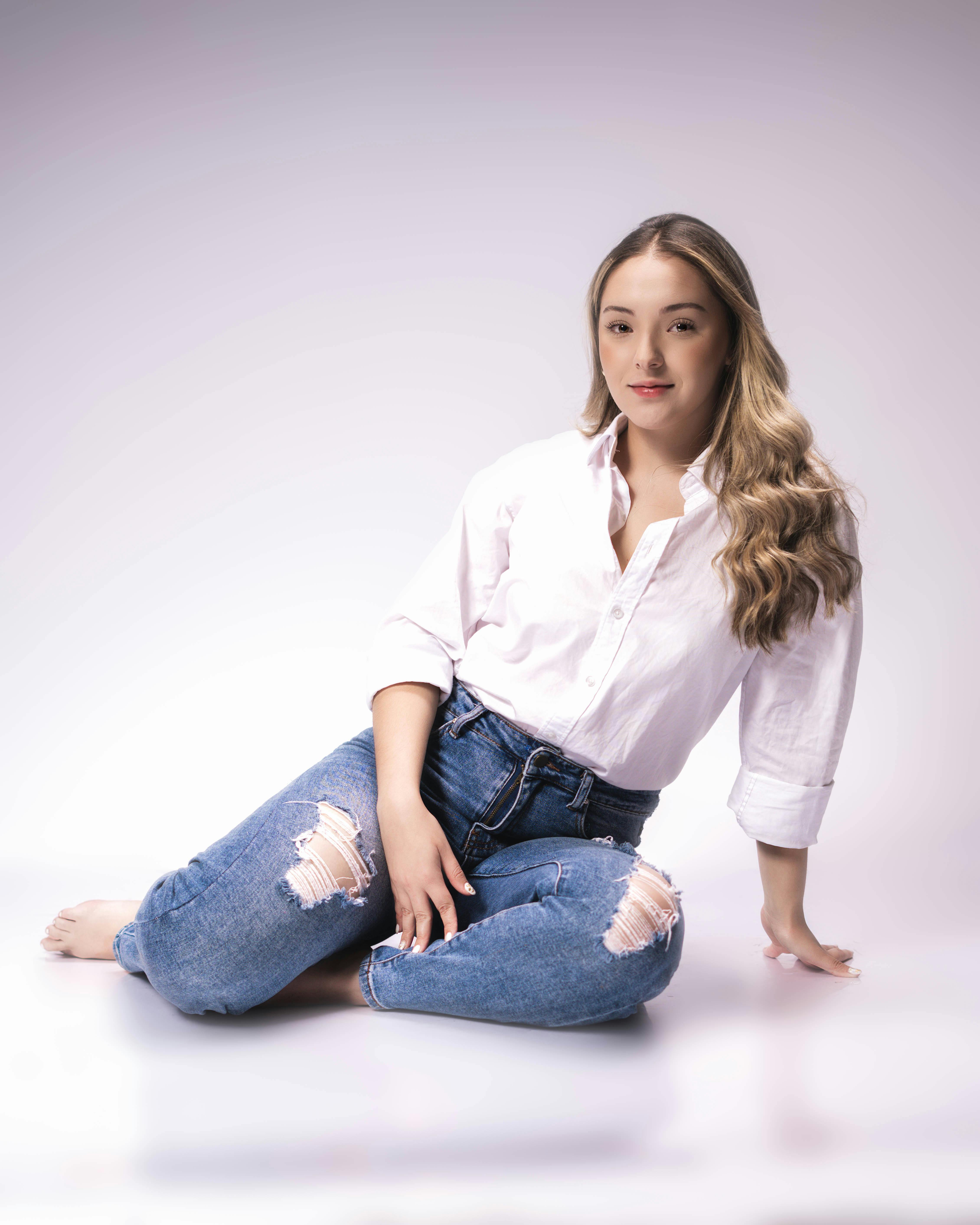 Young Woman Posing in Casual Outfit on White Background · Free Stock Photo