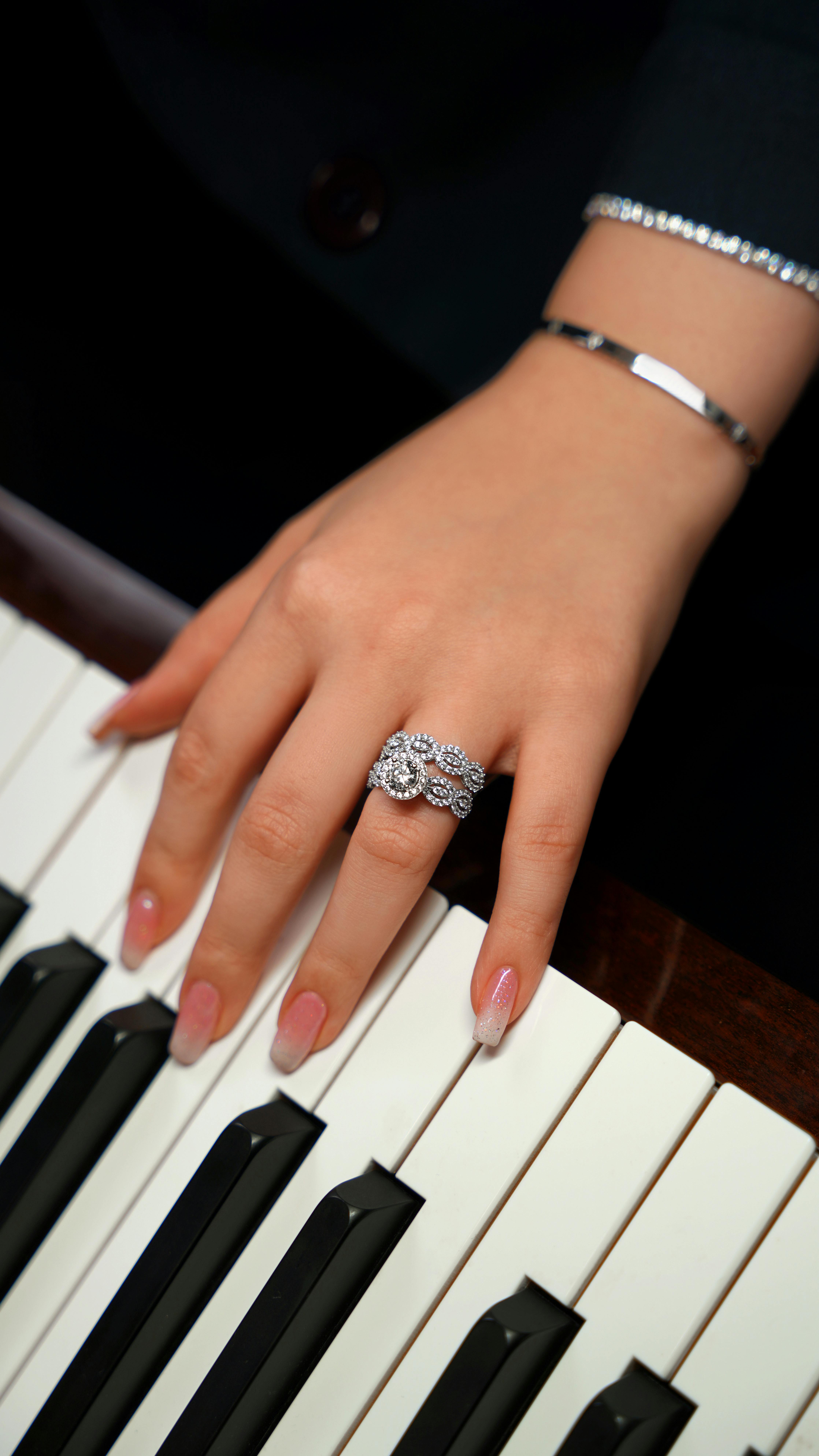 Elegant Hand with Jewelry Playing Piano Keys · Free Stock Photo
