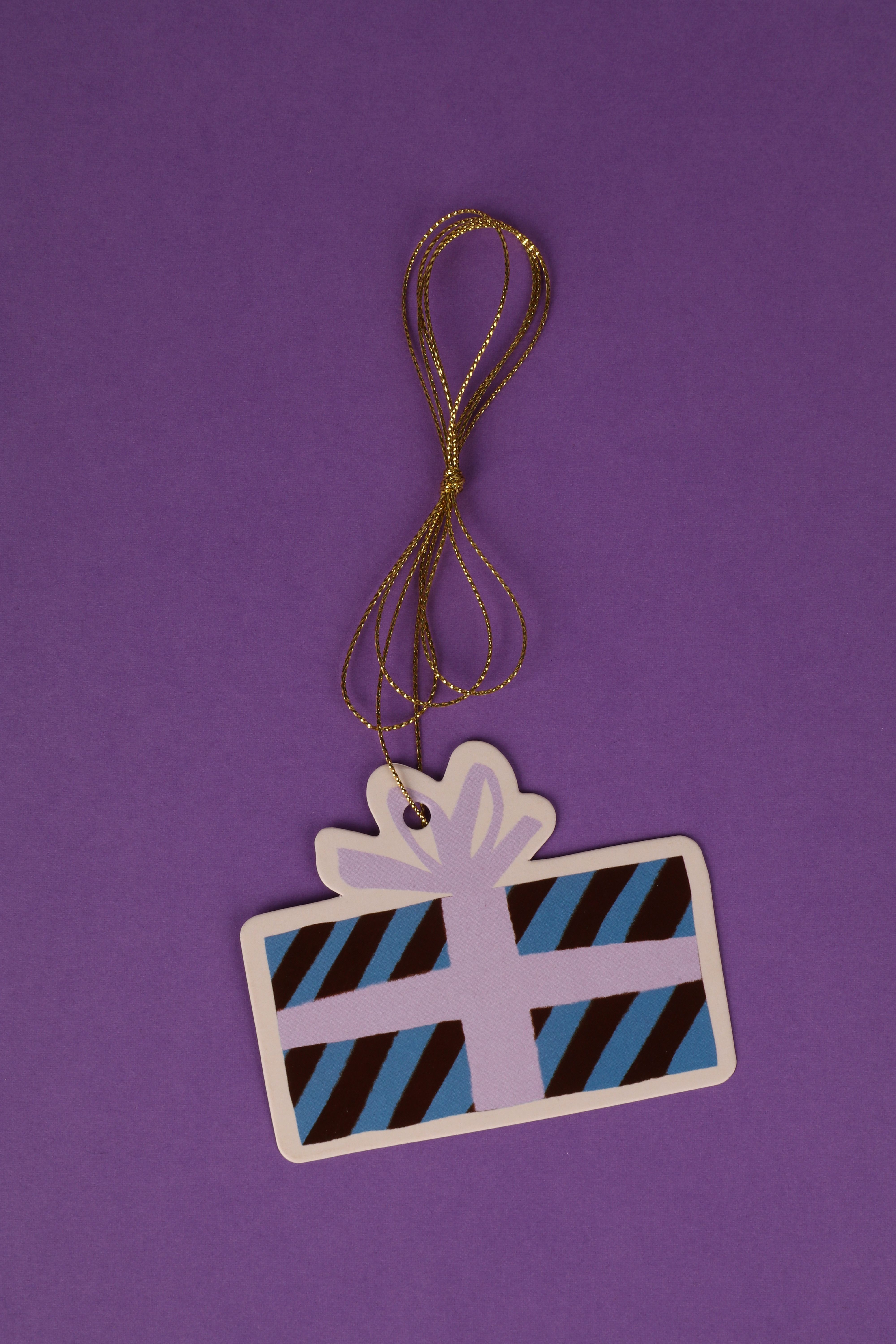 Colorful Gift Tag on Purple Background · Free Stock Photo