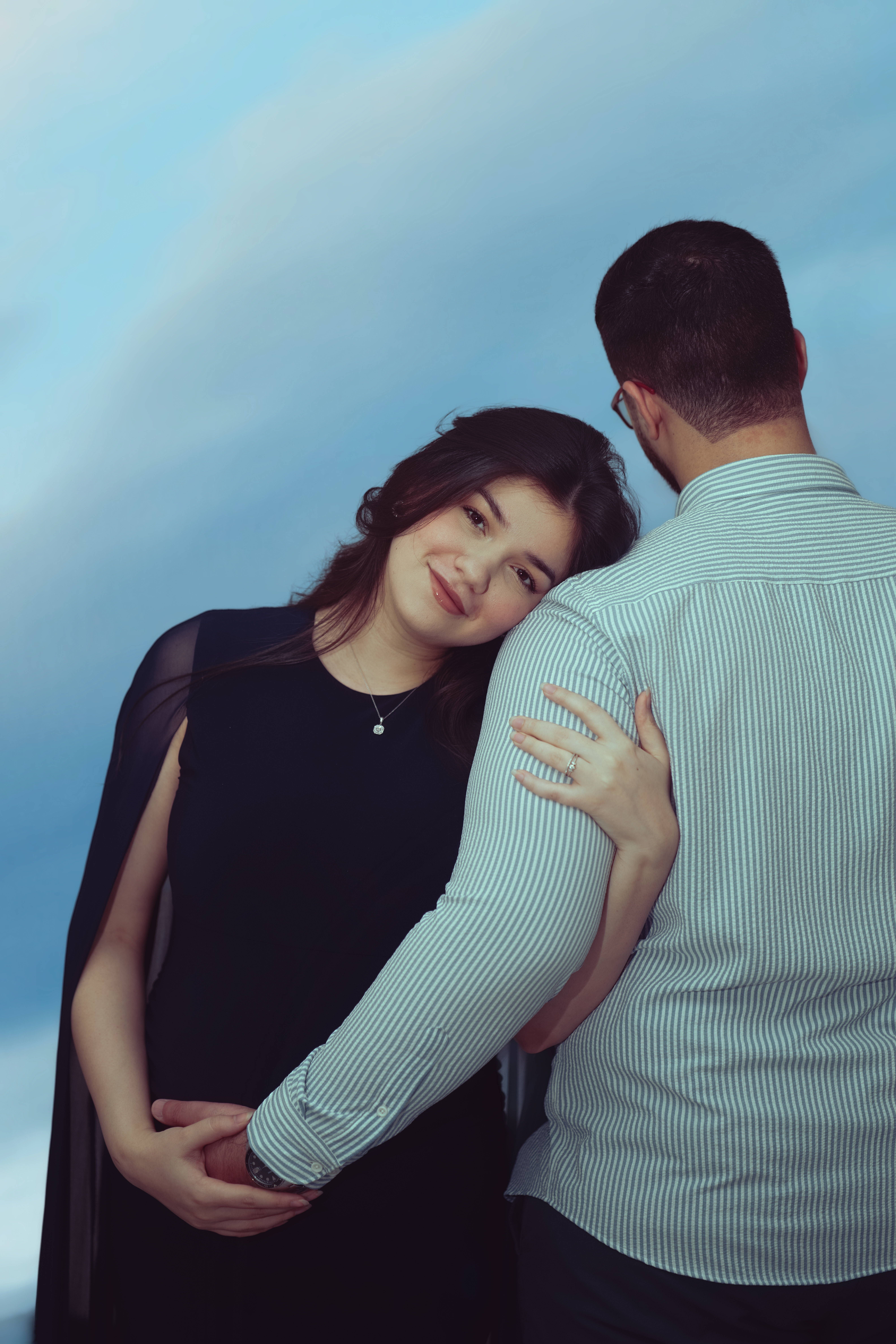 Romantic Couple Embracing Under Clear Sky · Free Stock Photo