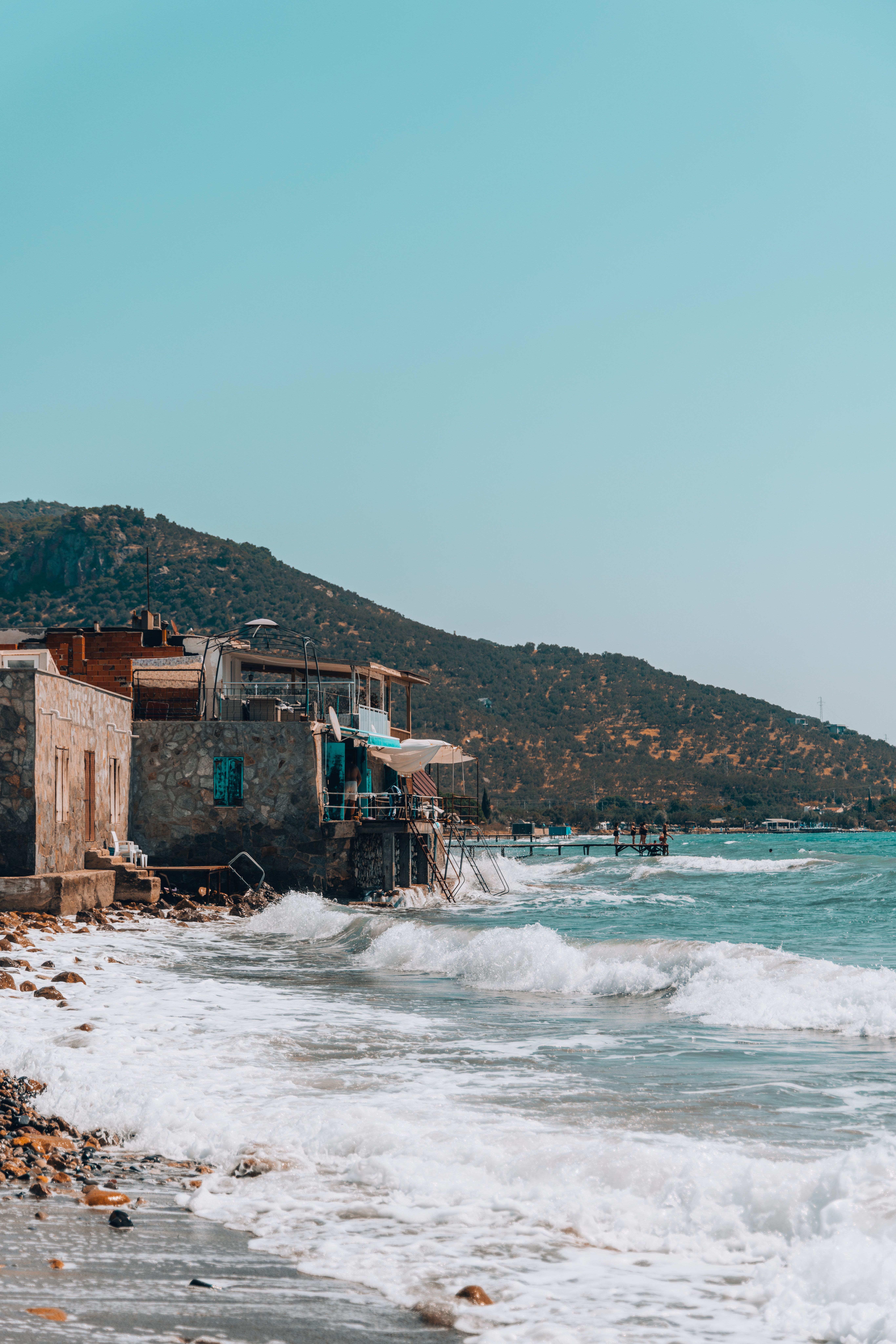 Seaside Village with Rocky Shoreline in Daylight · Free Stock Photo