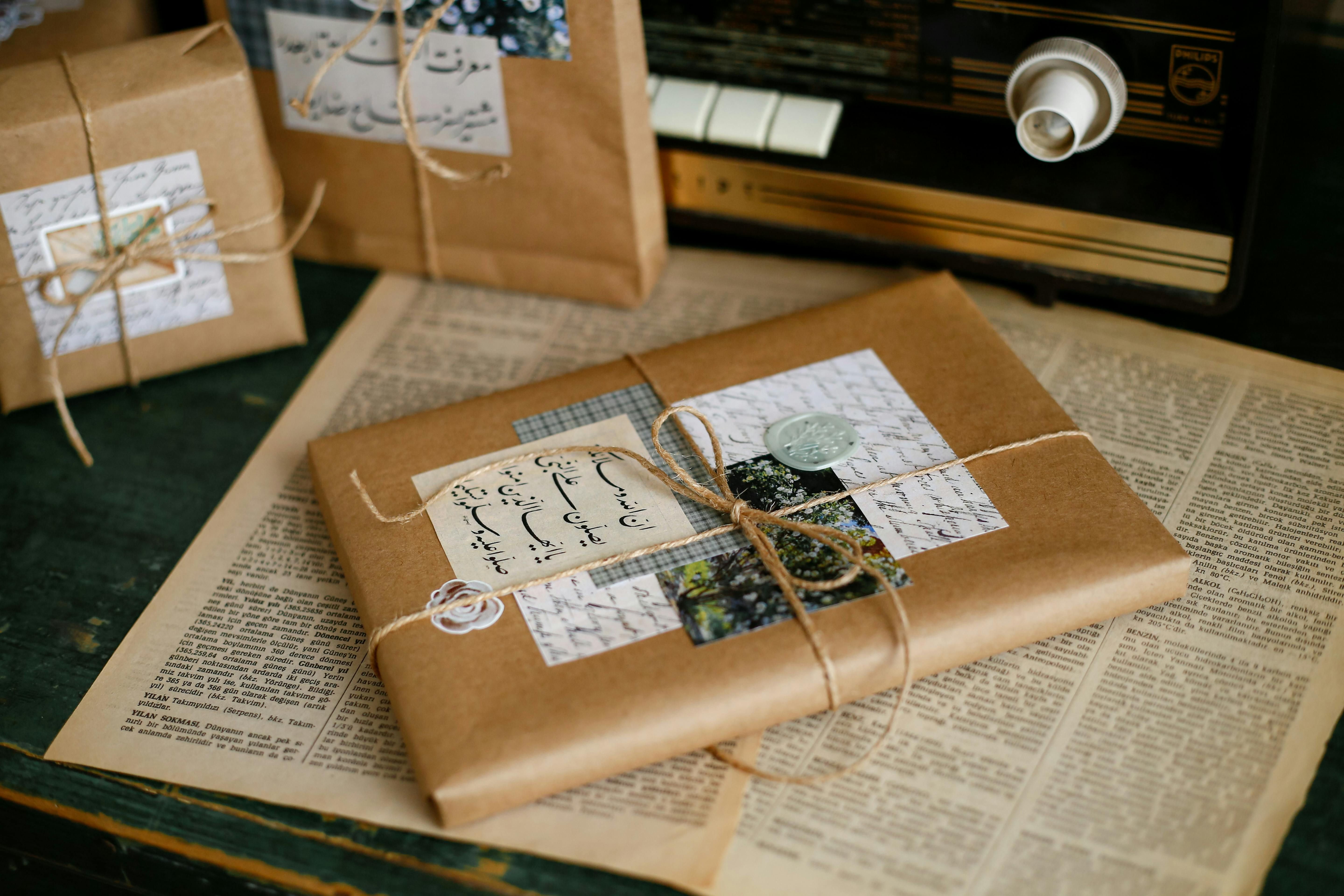 Vintage Gift Packages on Antique Radio and Book · Free Stock Photo