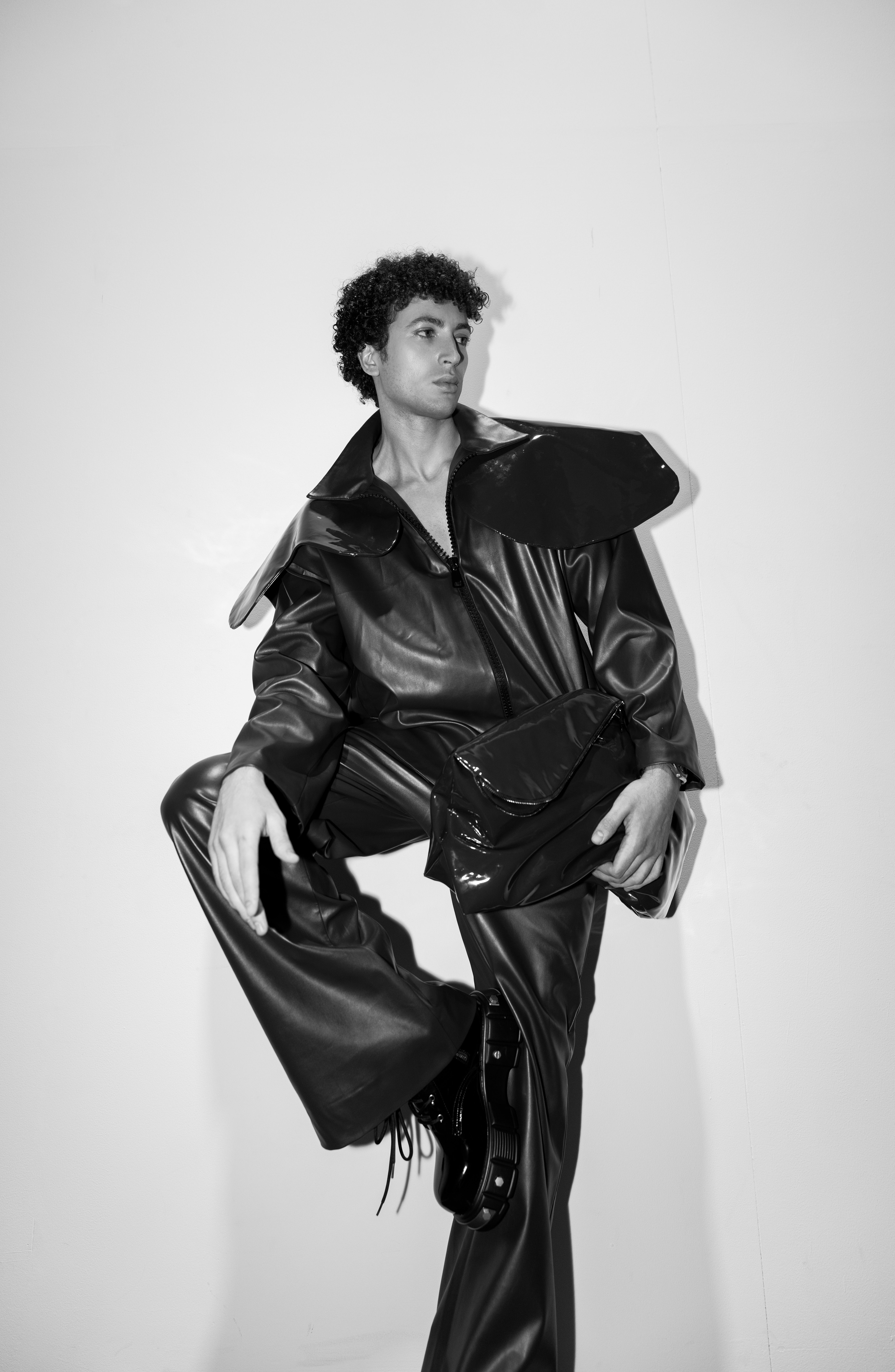 Stylish Man Posing in Black Vinyl Outfit · Free Stock Photo