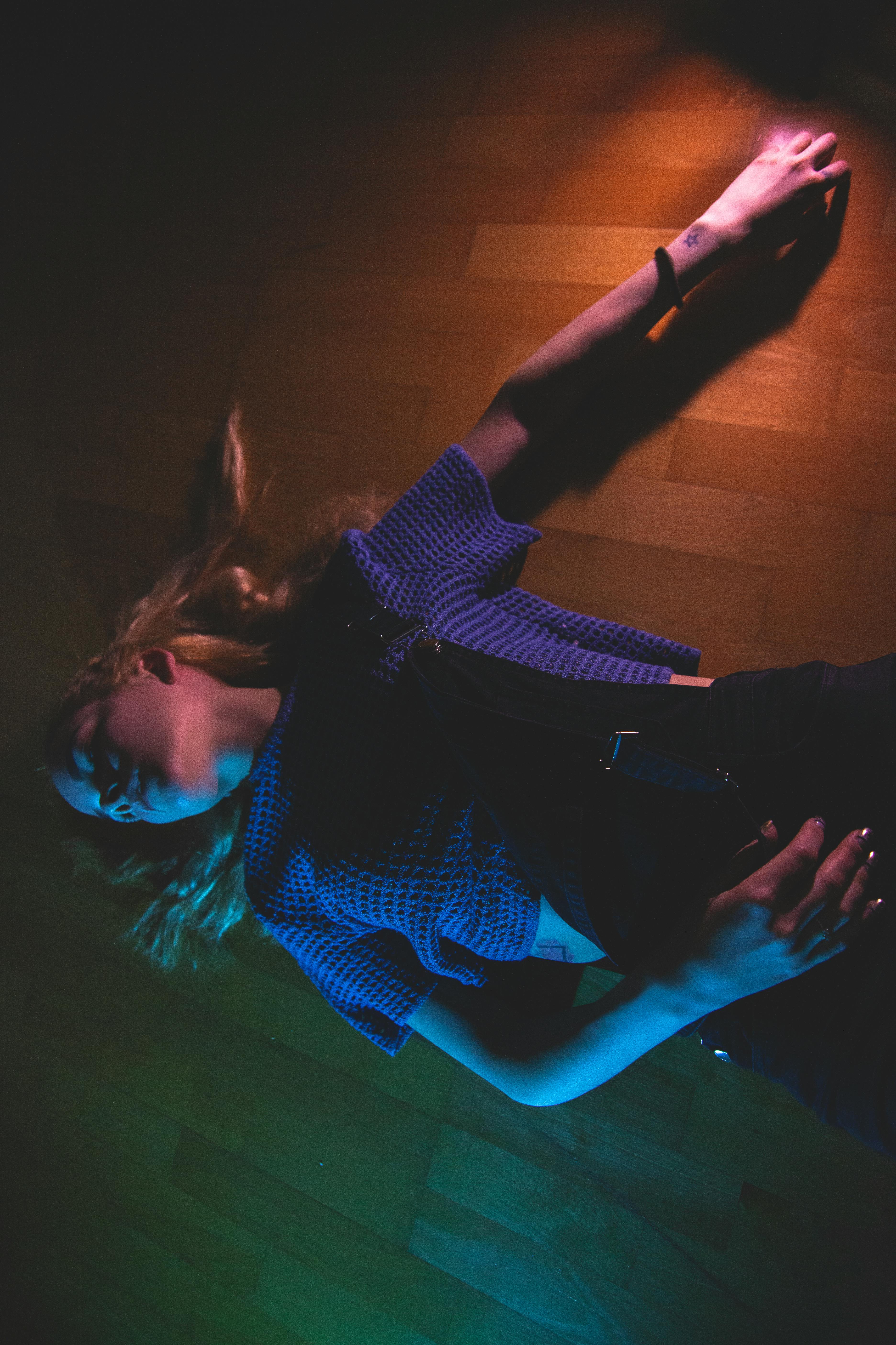 Woman Curled Up on Floor · Free Stock Photo