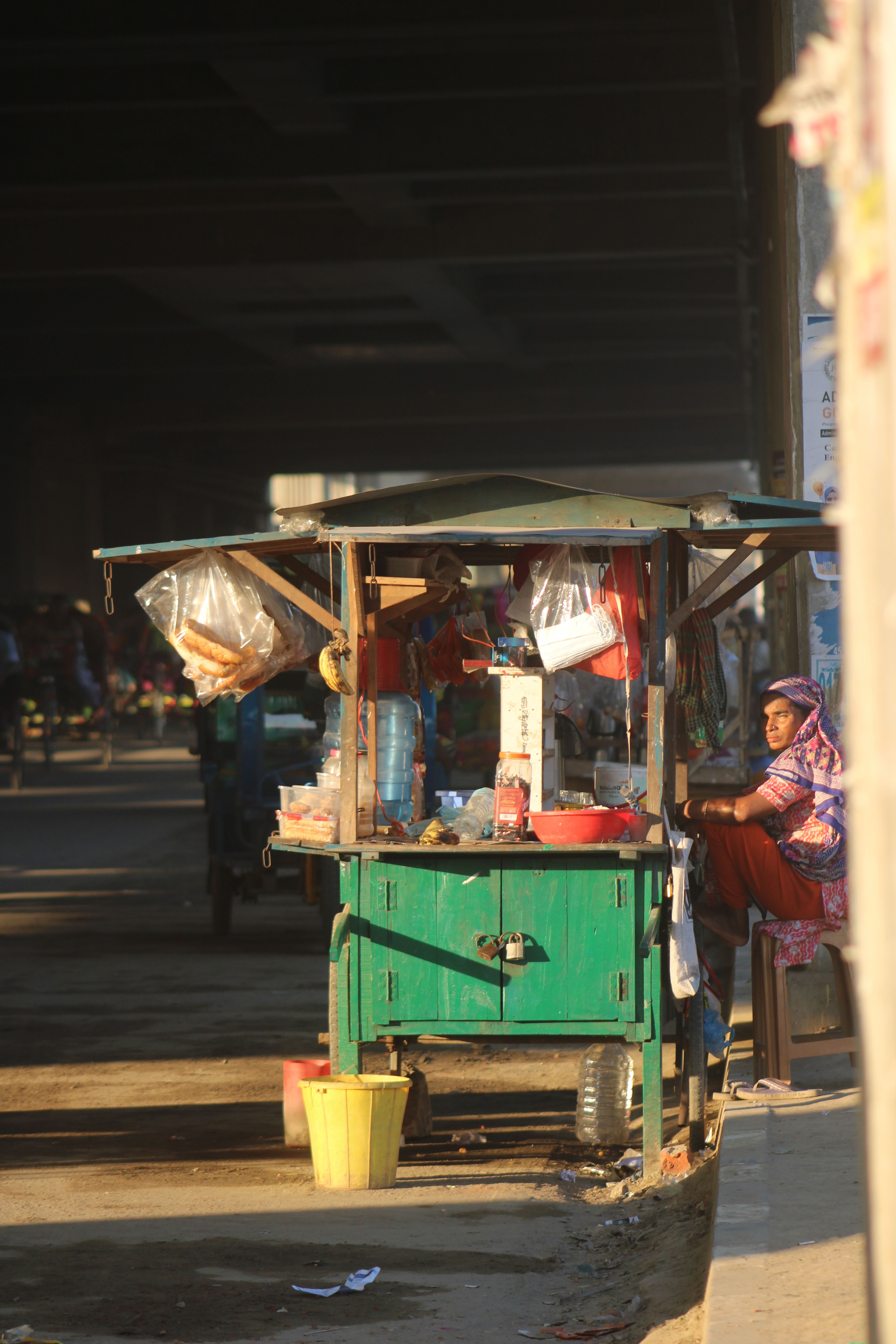 Street Vendor Stall Under Urban Bridge · Free Stock Photo