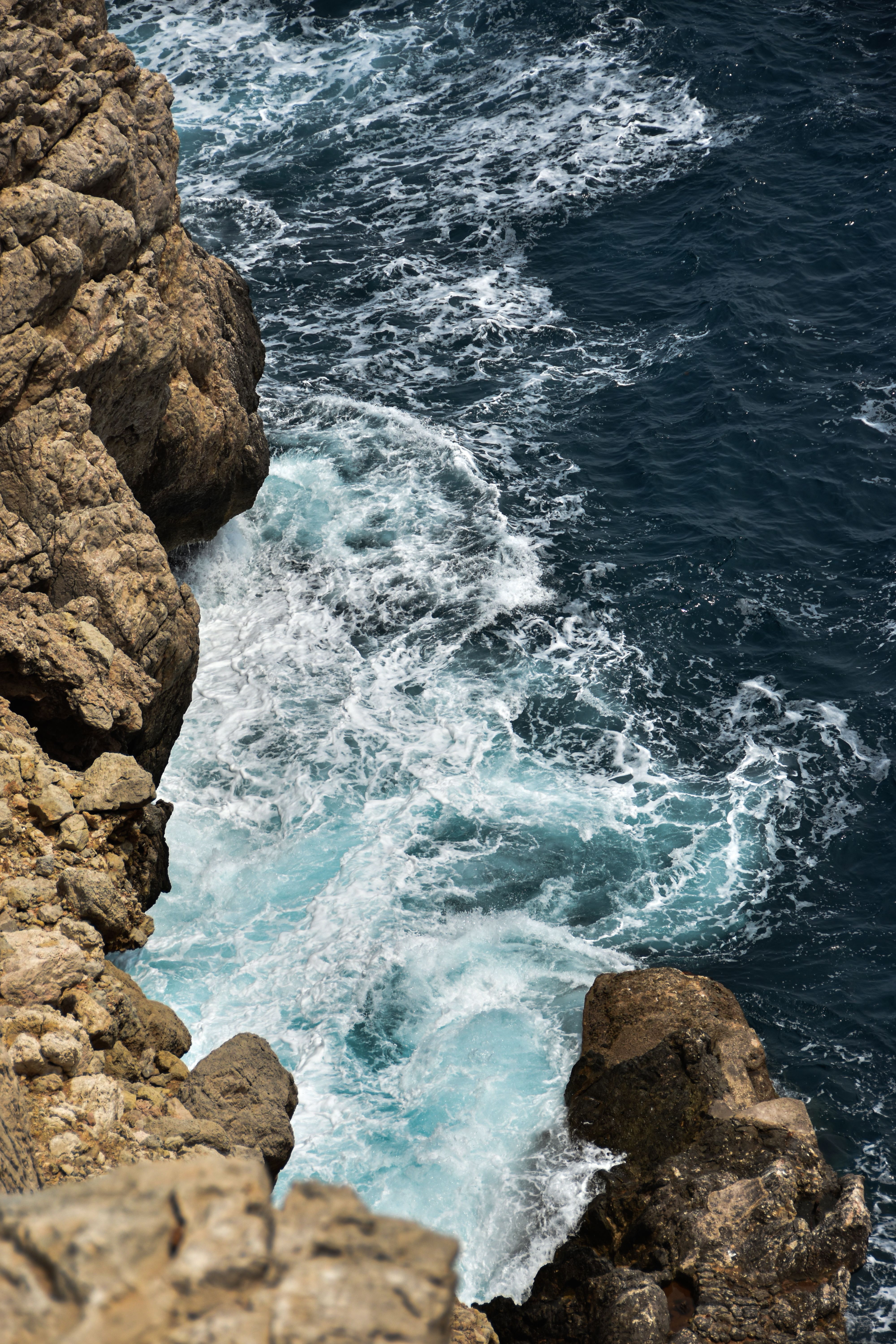 Closeup of Blue Sea Water Splashing against a Rocky Coast · Free Stock ...