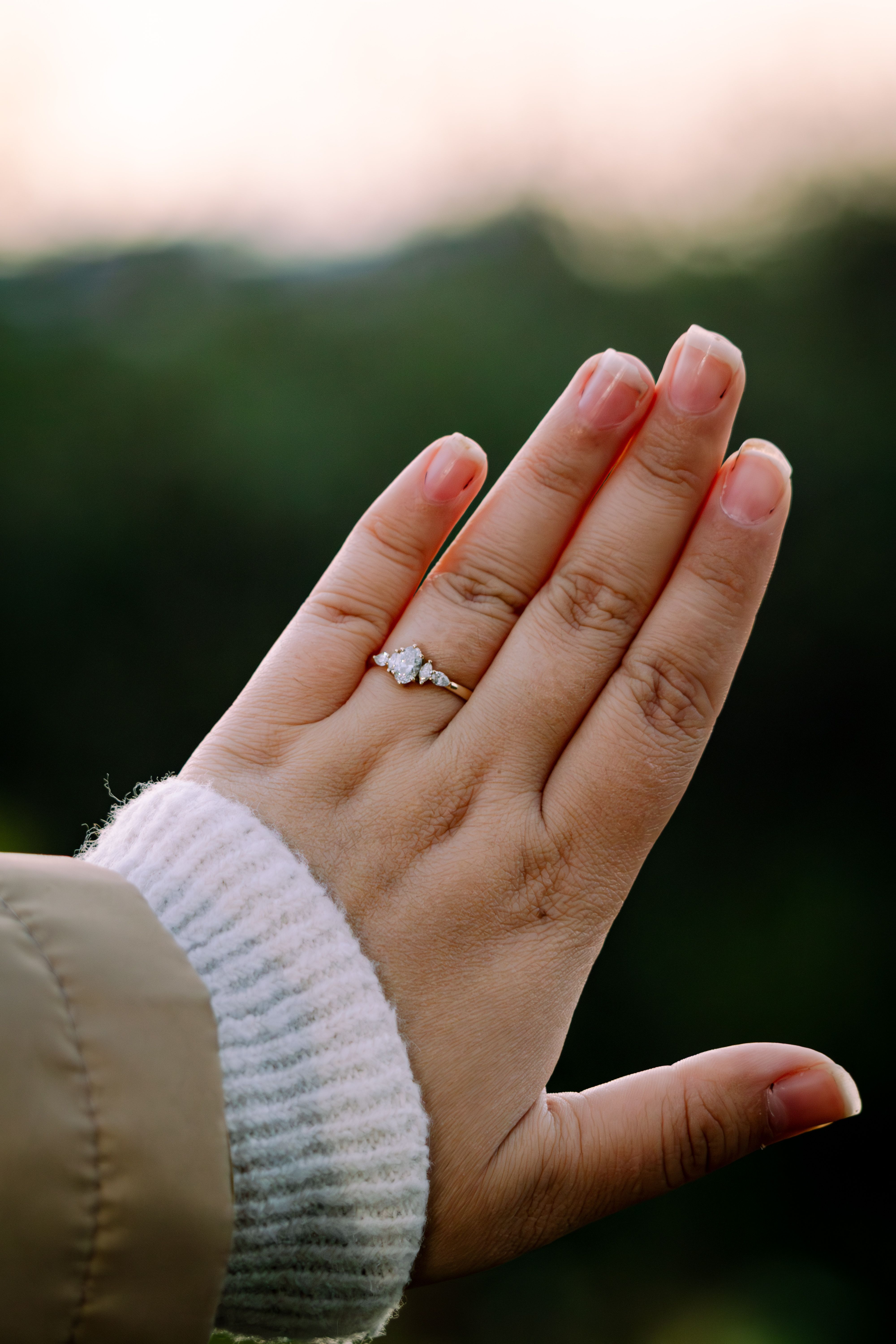 Close-up of Hand with Engagement Ring Outdoors · Free Stock Photo