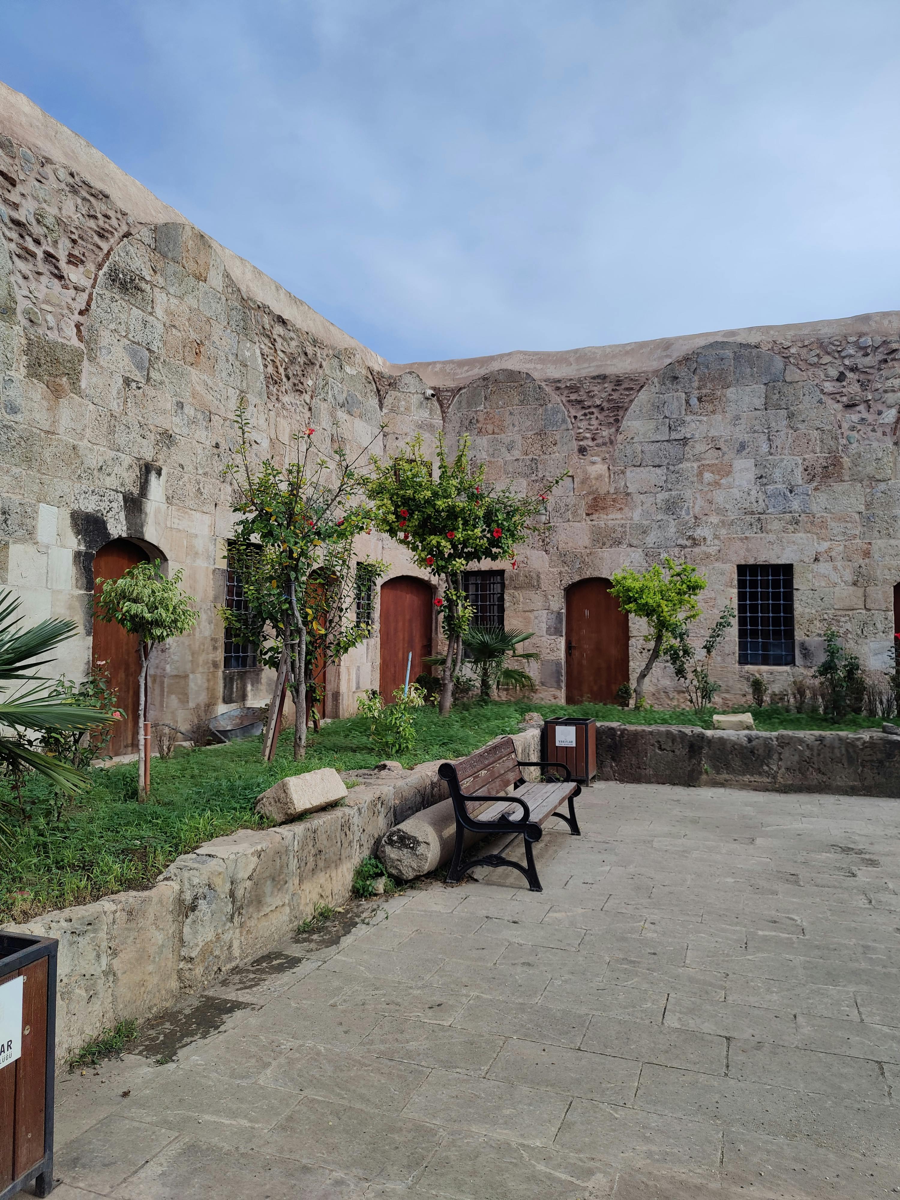 Historic Stone Courtyard with Arched Walls · Free Stock Photo