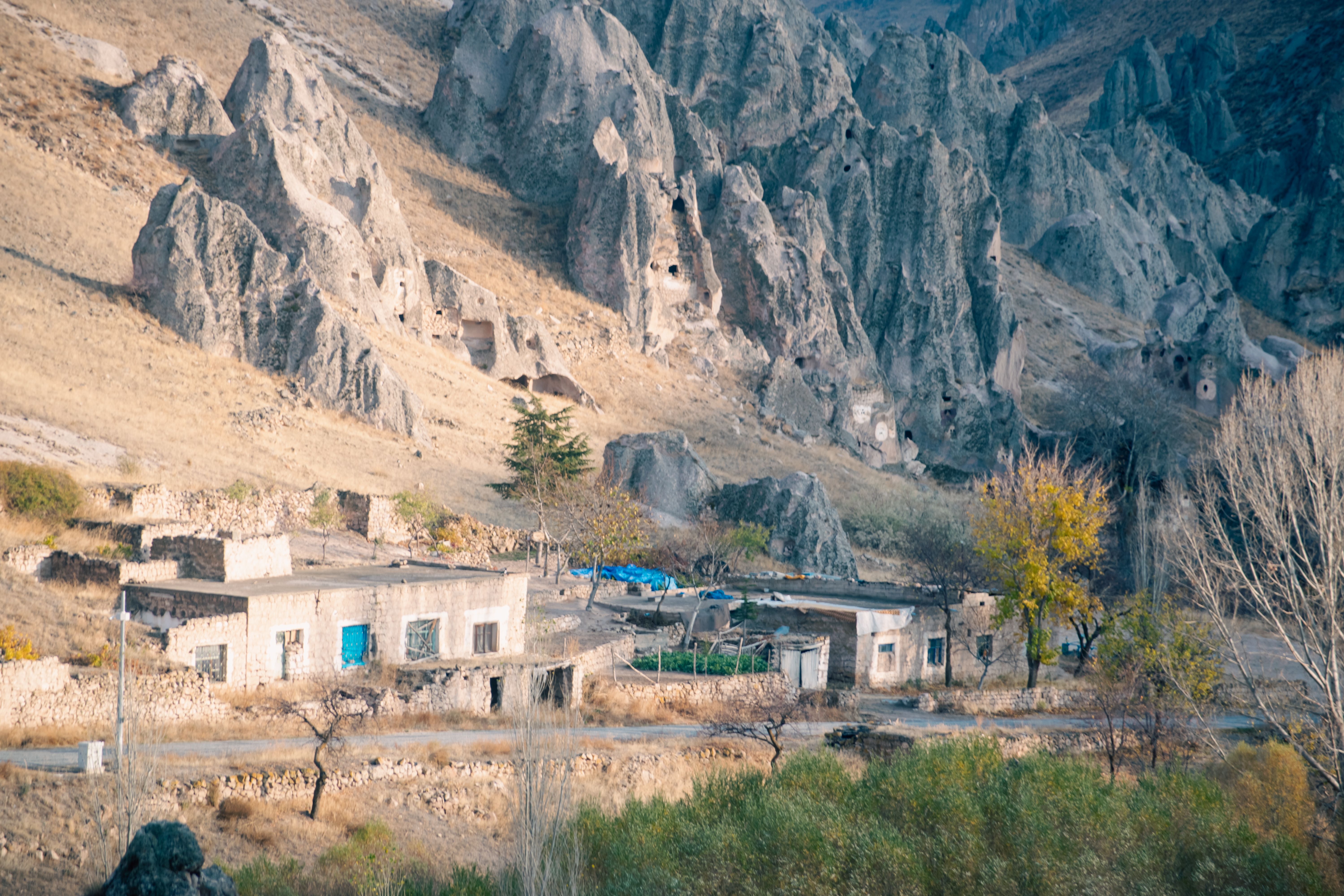 Remote Village Landscape Amidst Rocky Hills · Free Stock Photo