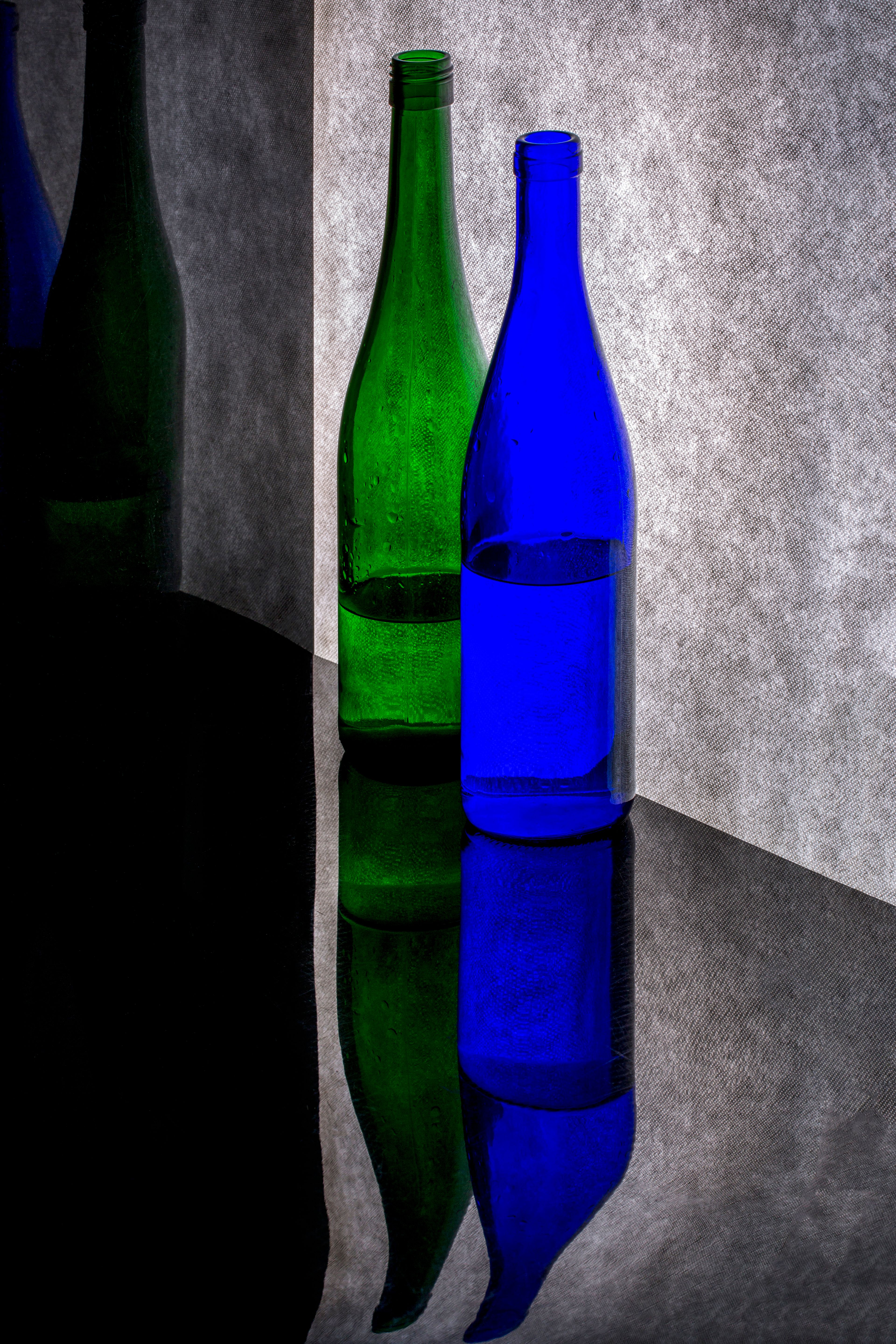 Colorful Glass Bottles with Reflections · Free Stock Photo