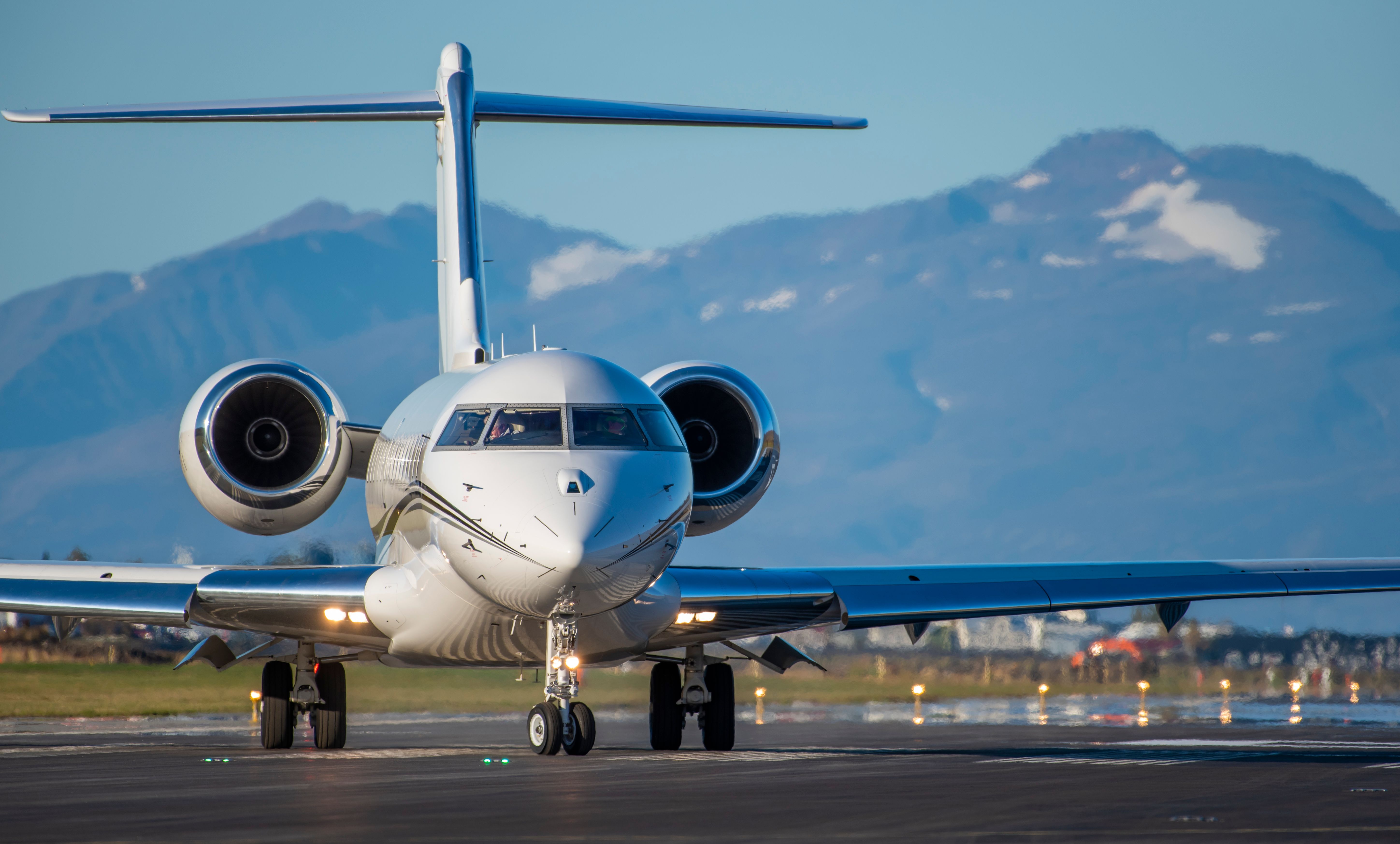 Private Jet on Airport Runway with Mountain View · Free Stock Photo