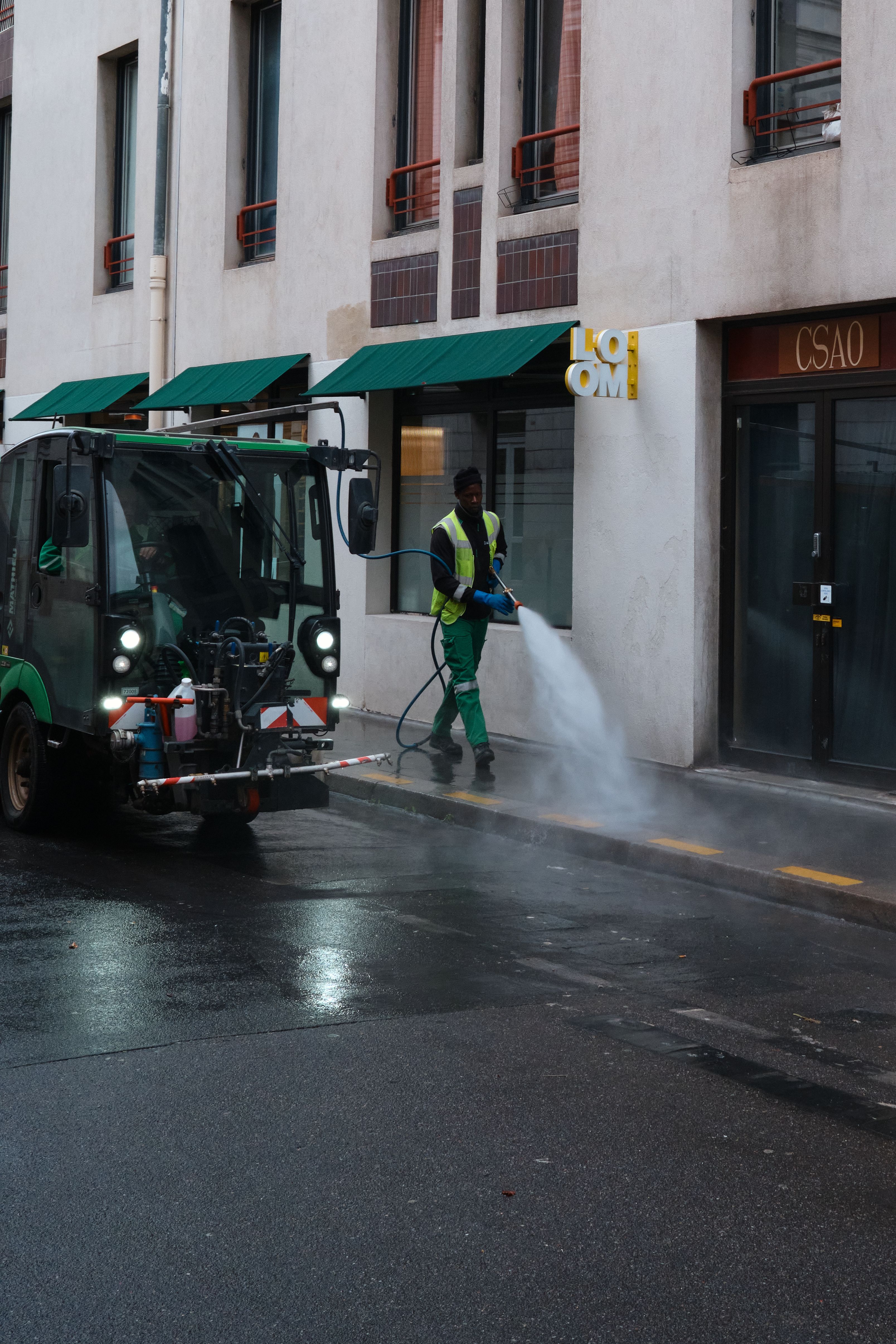 Street Cleaning Operation with Water Spray · Free Stock Photo