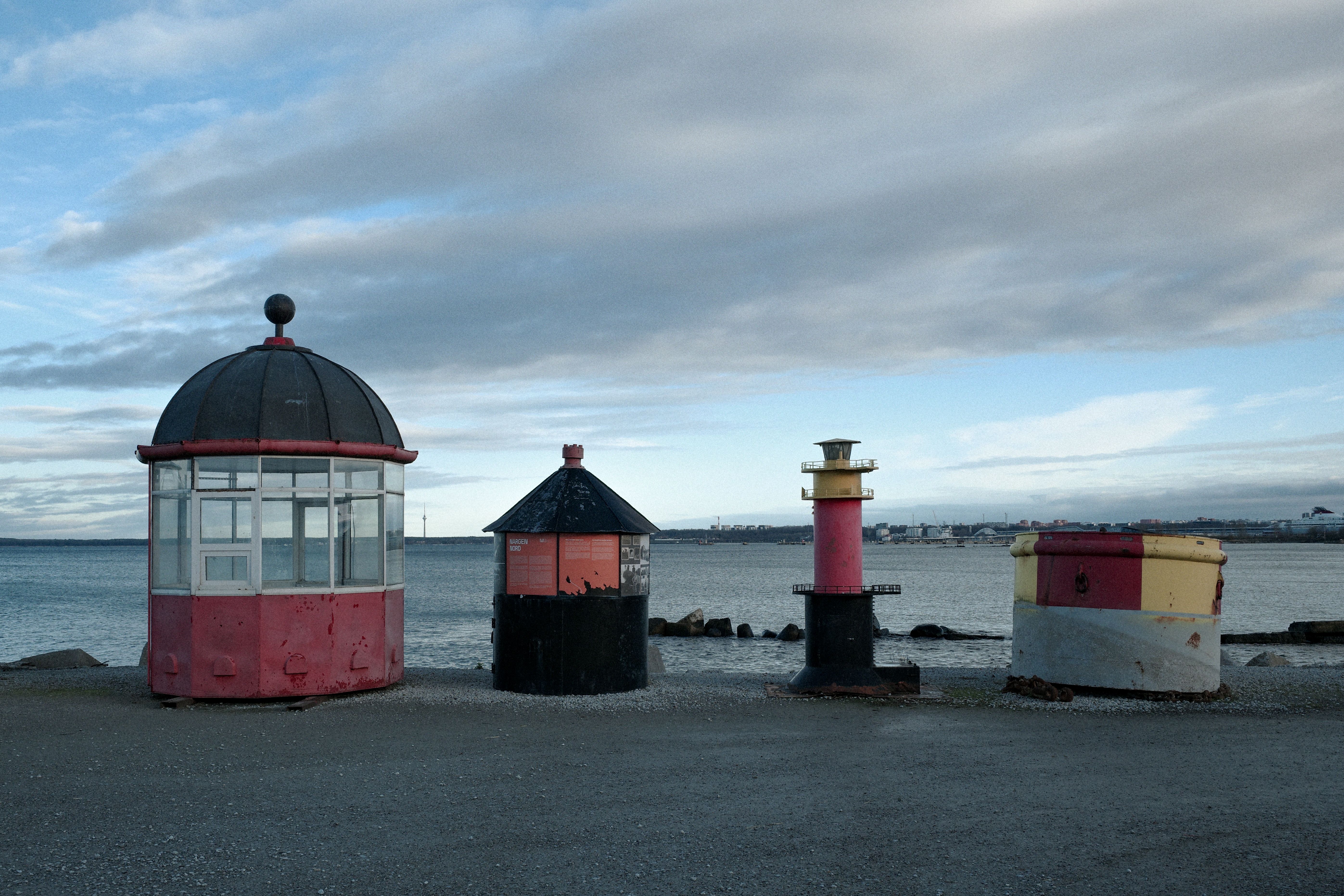 Colorful Lighthouse Structures by the Seashore · Free Stock Photo