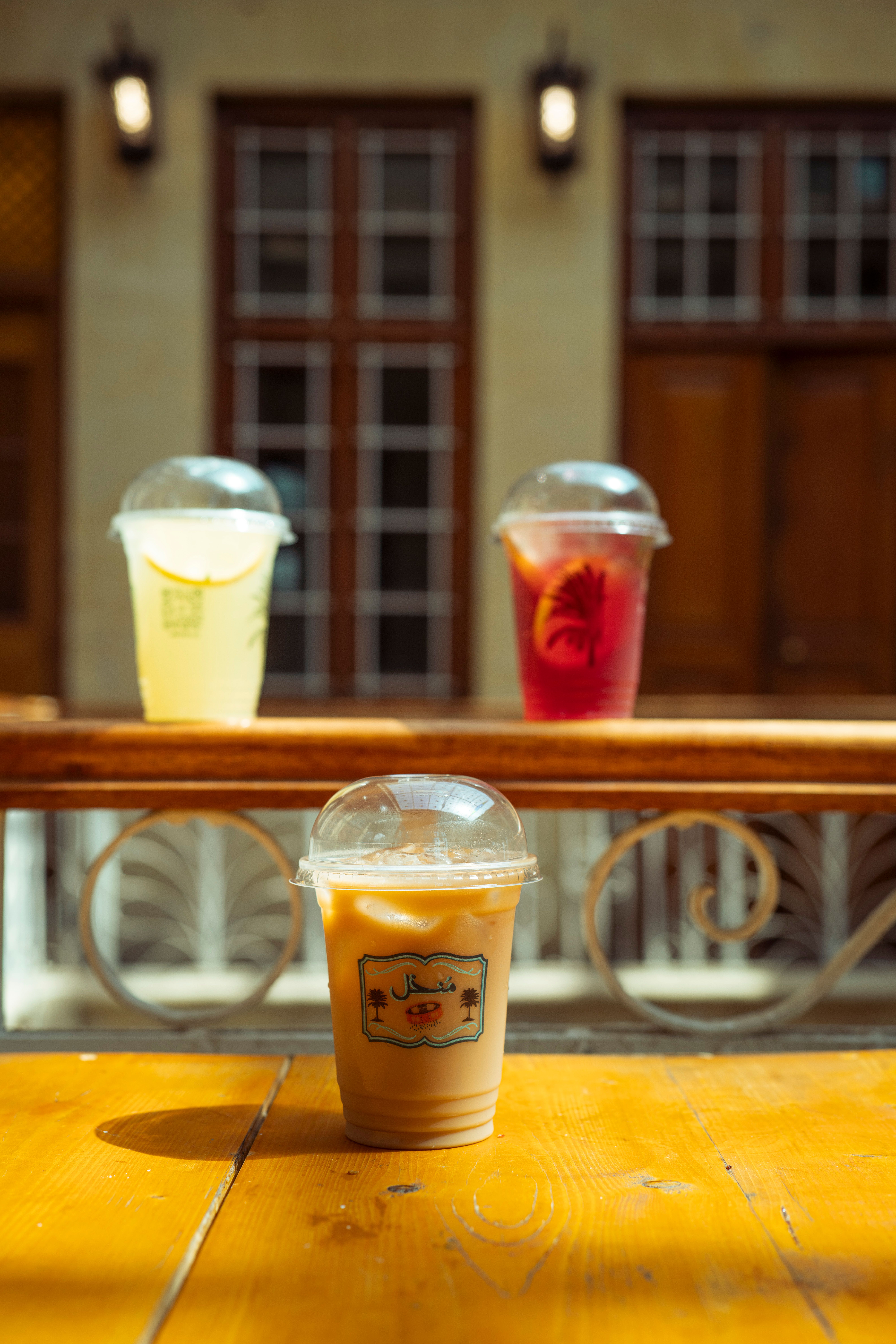 Assorted Cold Drinks on a Sunny Cafe Table · Free Stock Photo