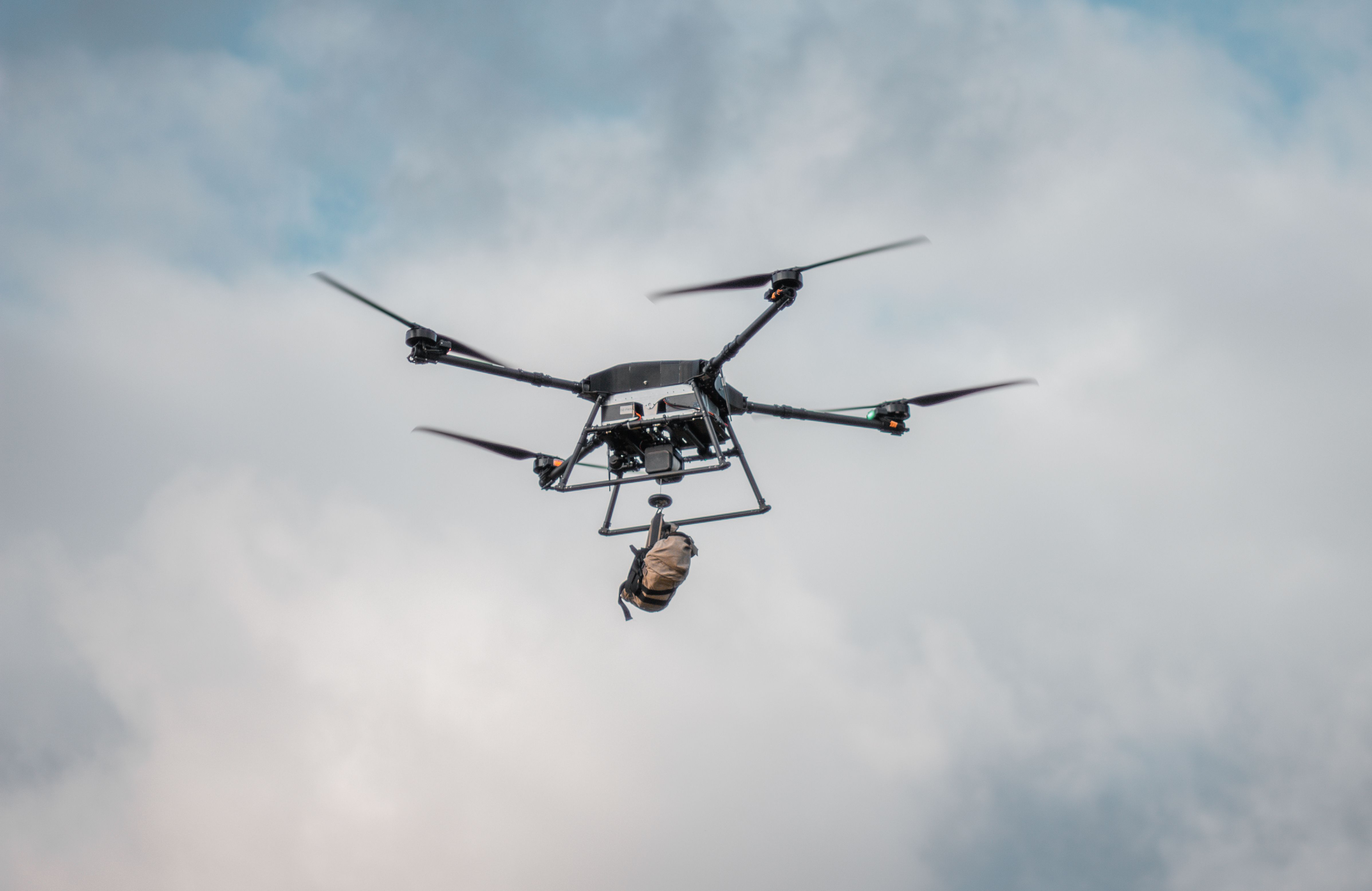 Powerful Drone Carrying Payload Midflight · Free Stock Photo