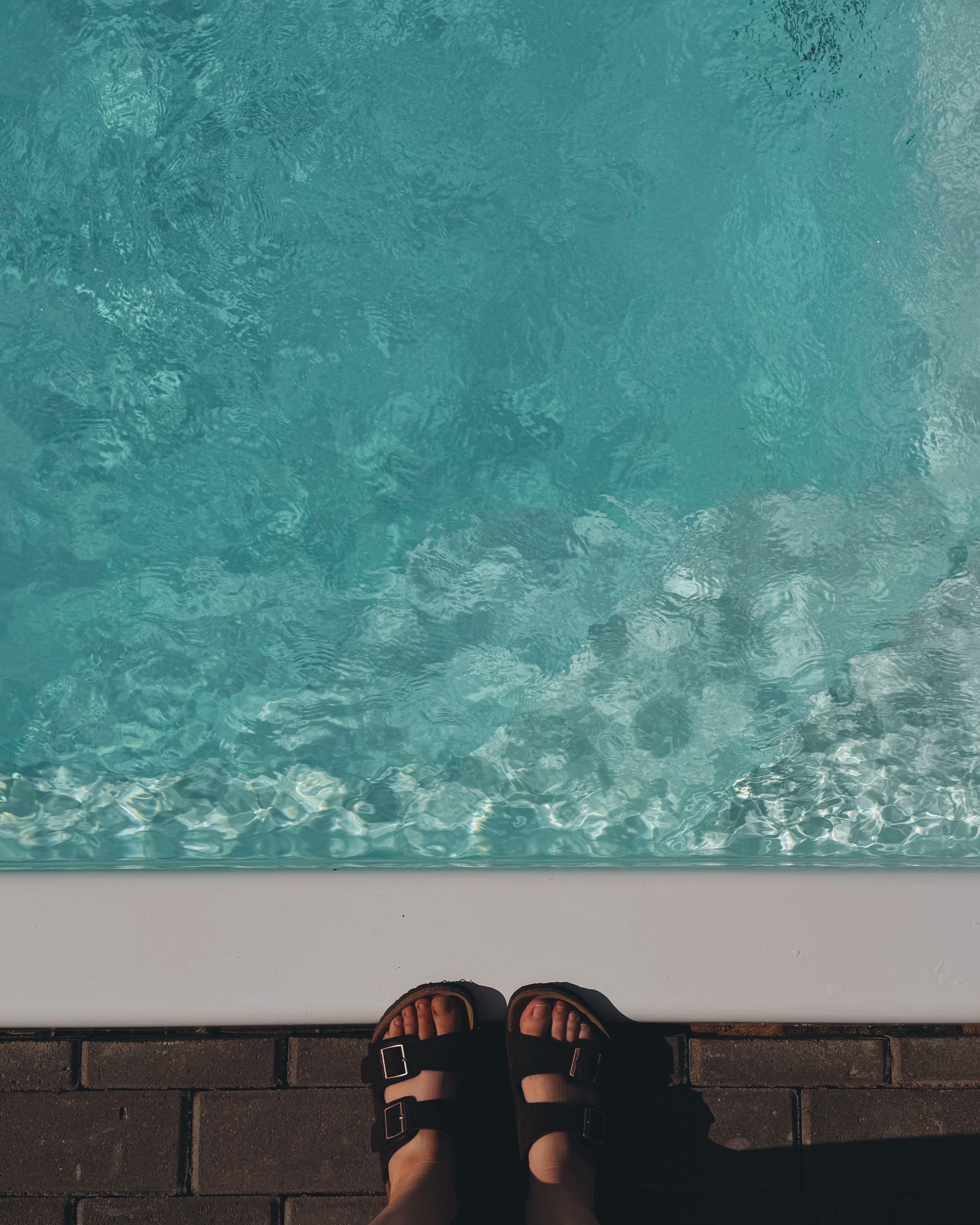 Relax by the Poolside with Sandals and Water · Free Stock Photo
