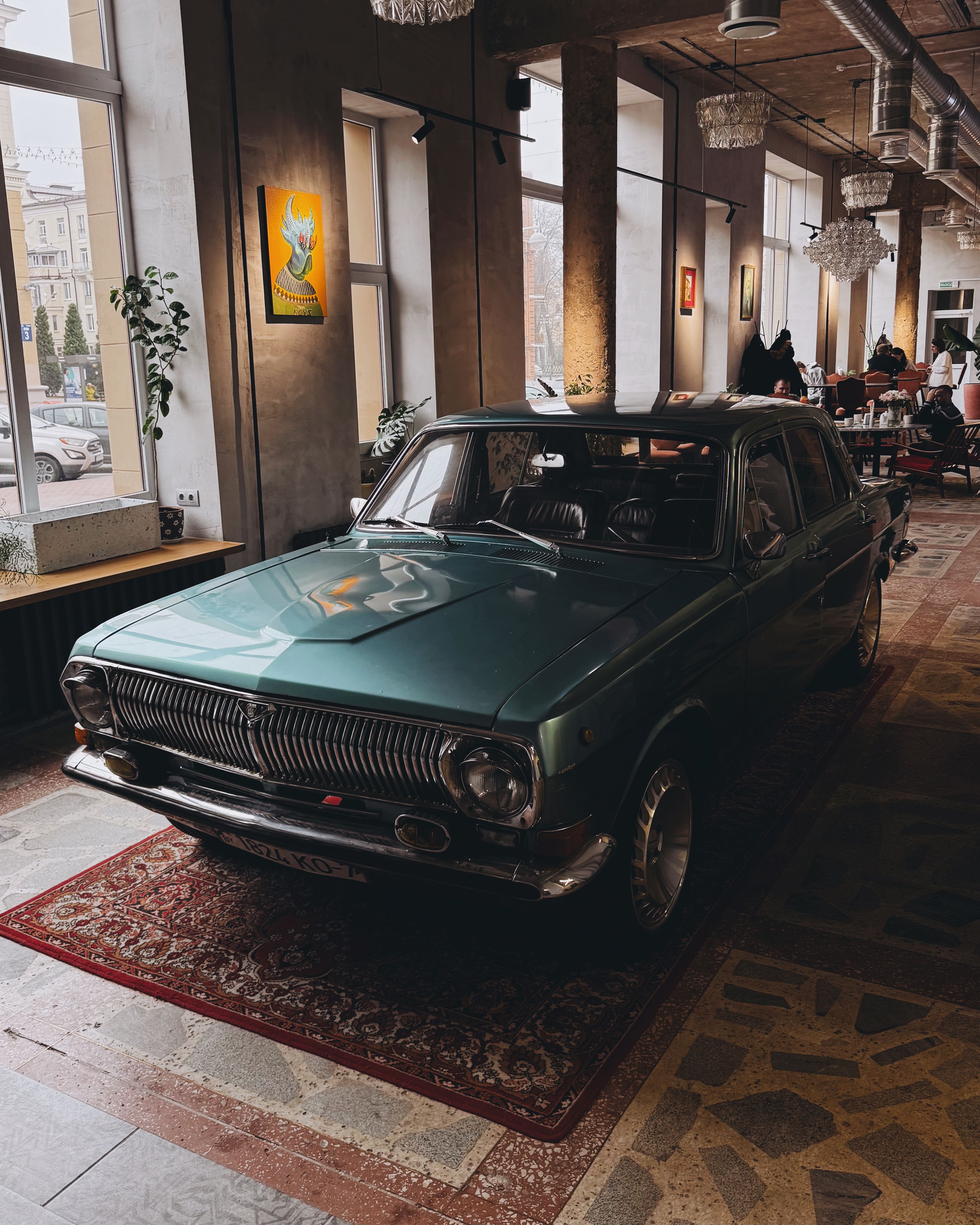 Vintage Car Display in Trendy Cafe Setting · Free Stock Photo
