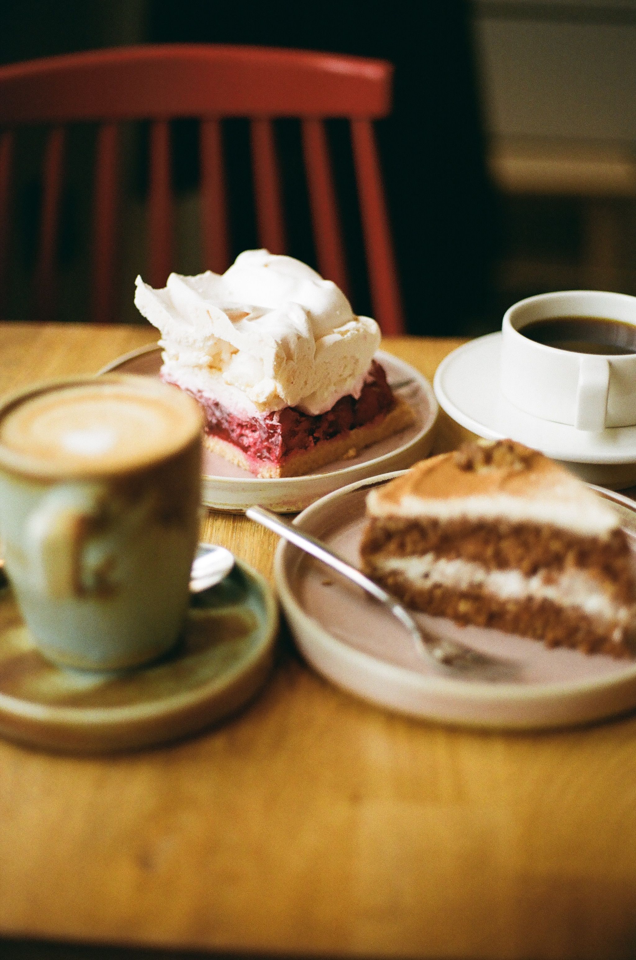 Cozy Café Scene with Cappuccino and Pastry · Free Stock Photo