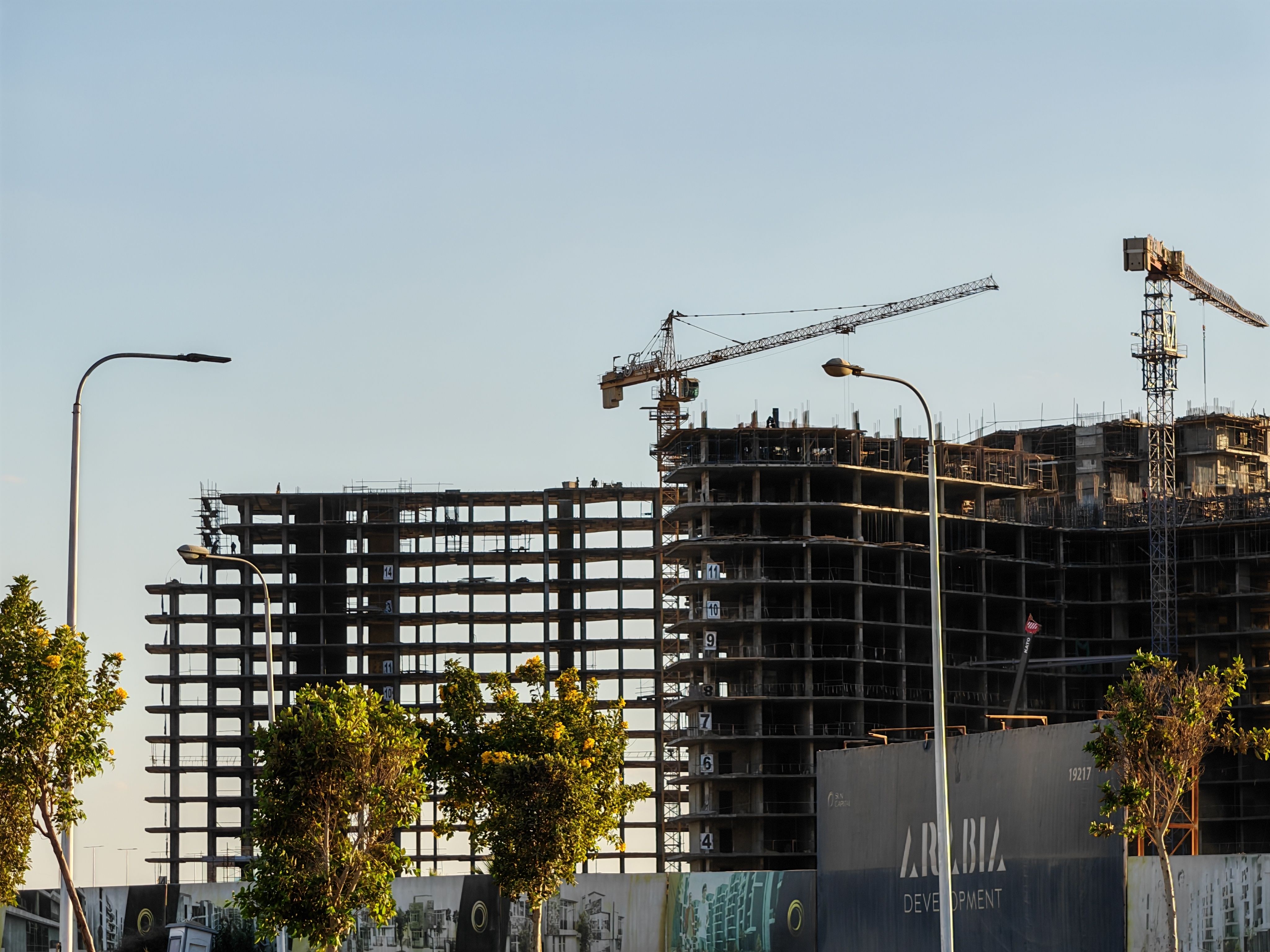 Construction Site with Cranes and Building Framework · Free Stock Photo
