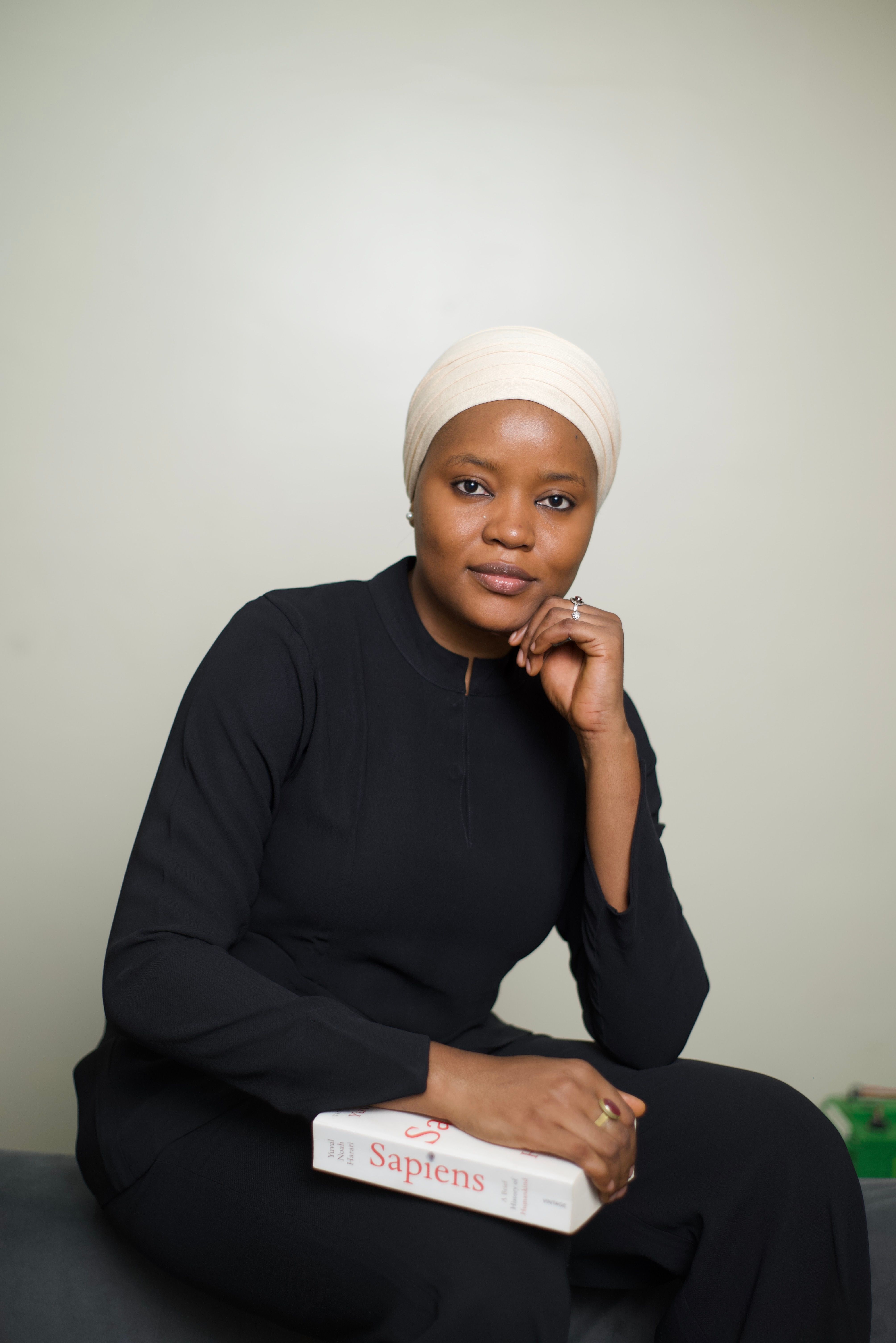 Thoughtful African Woman Reading Indoors Portrait · Free Stock Photo