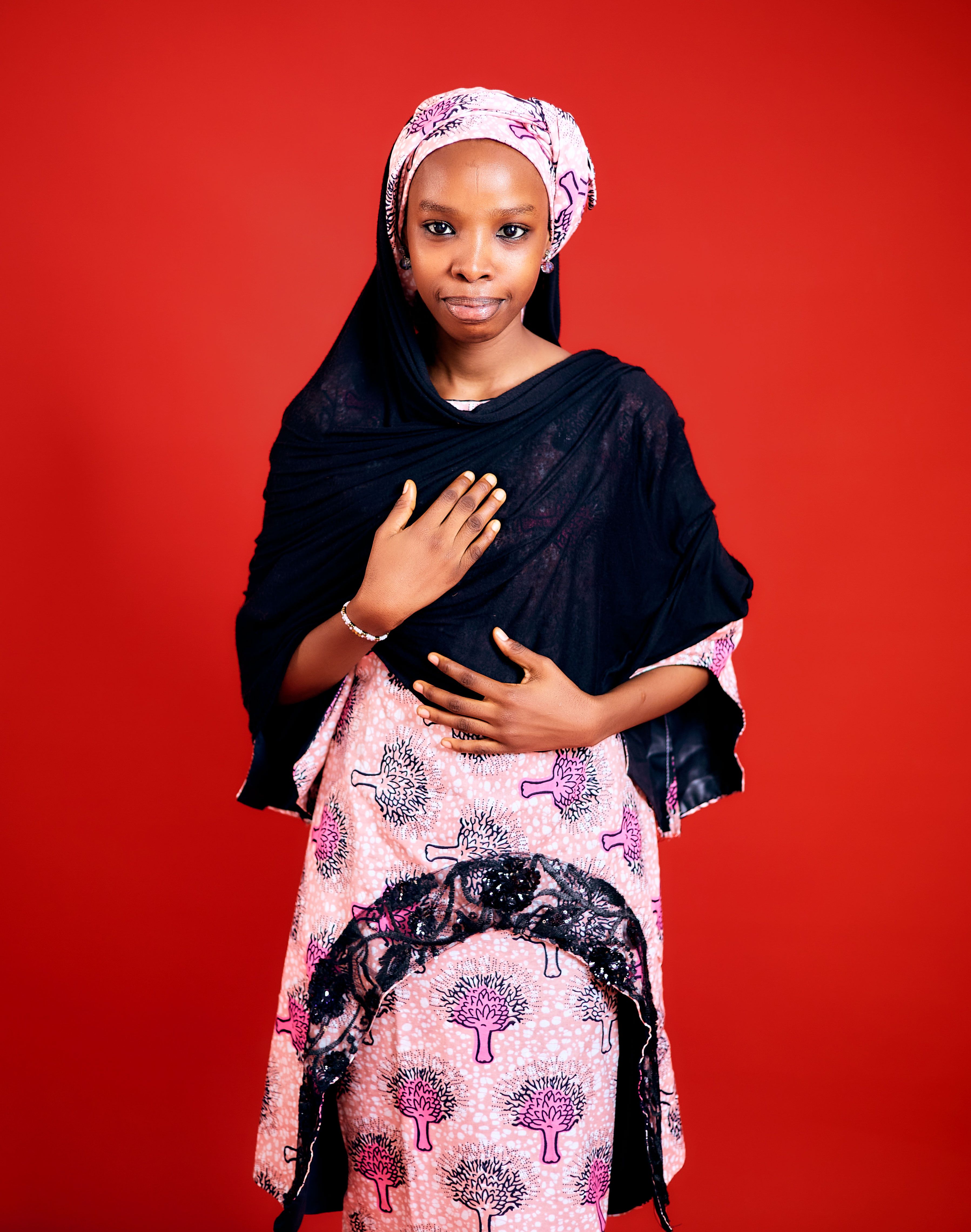 Traditional Attire Portrait on Red Background · Free Stock Photo