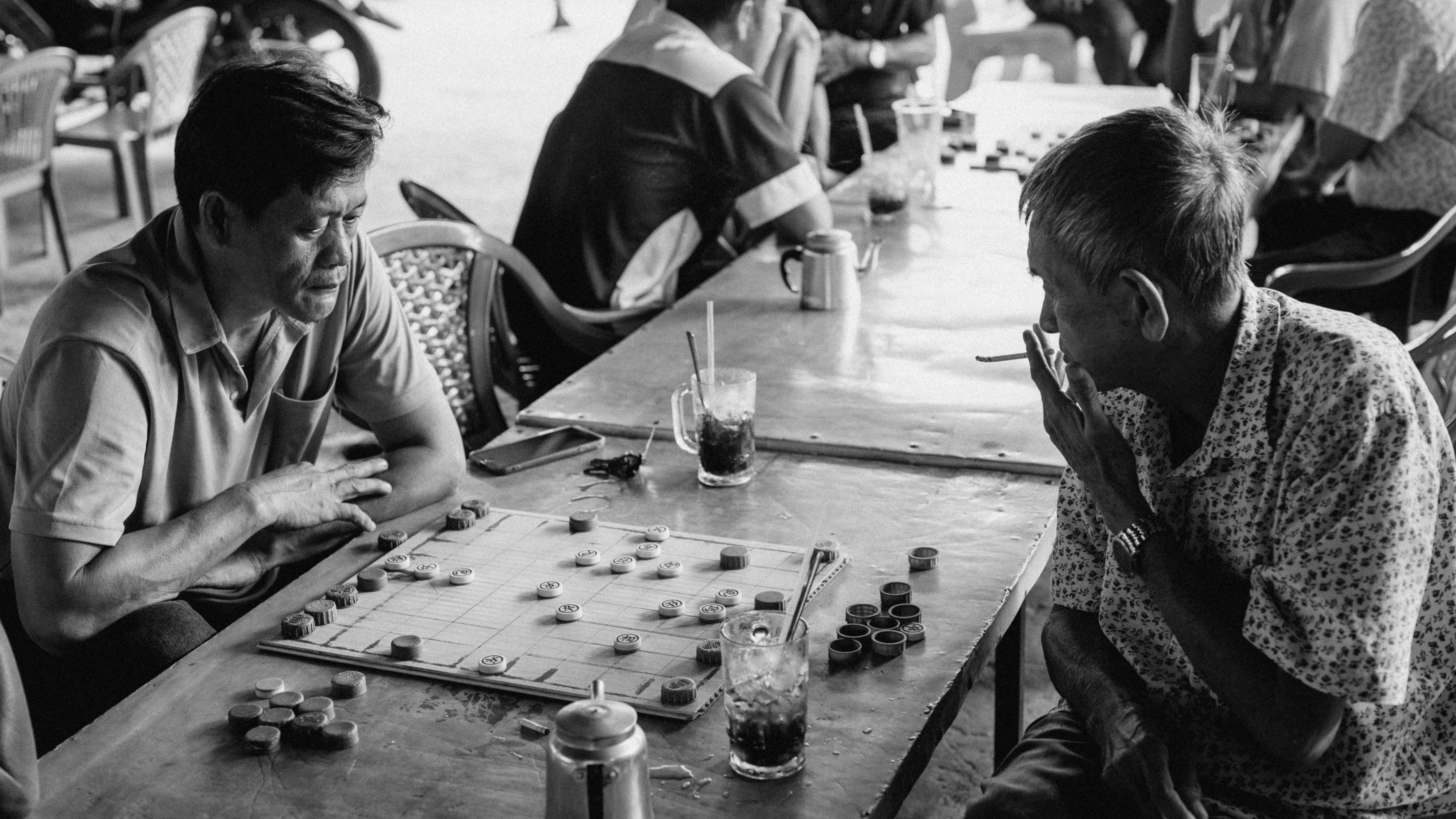 Men Playing Traditional Board Game Outdoors · Free Stock Photo