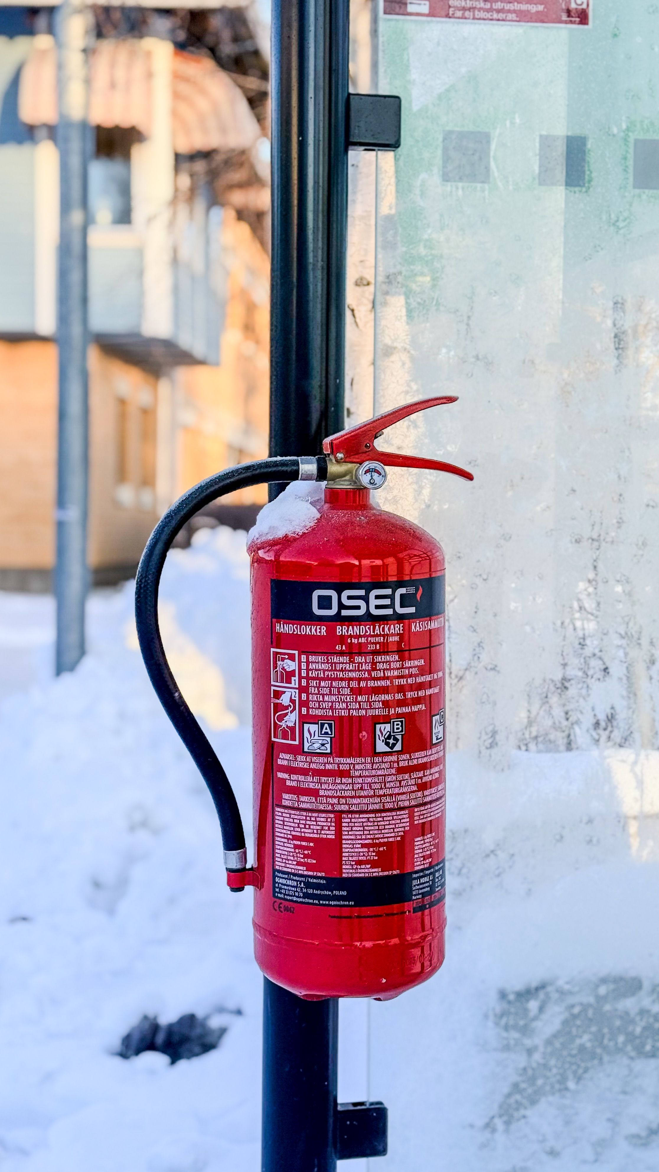 Fire Extinguisher at Swedish Winter Bus Stop · Free Stock Photo