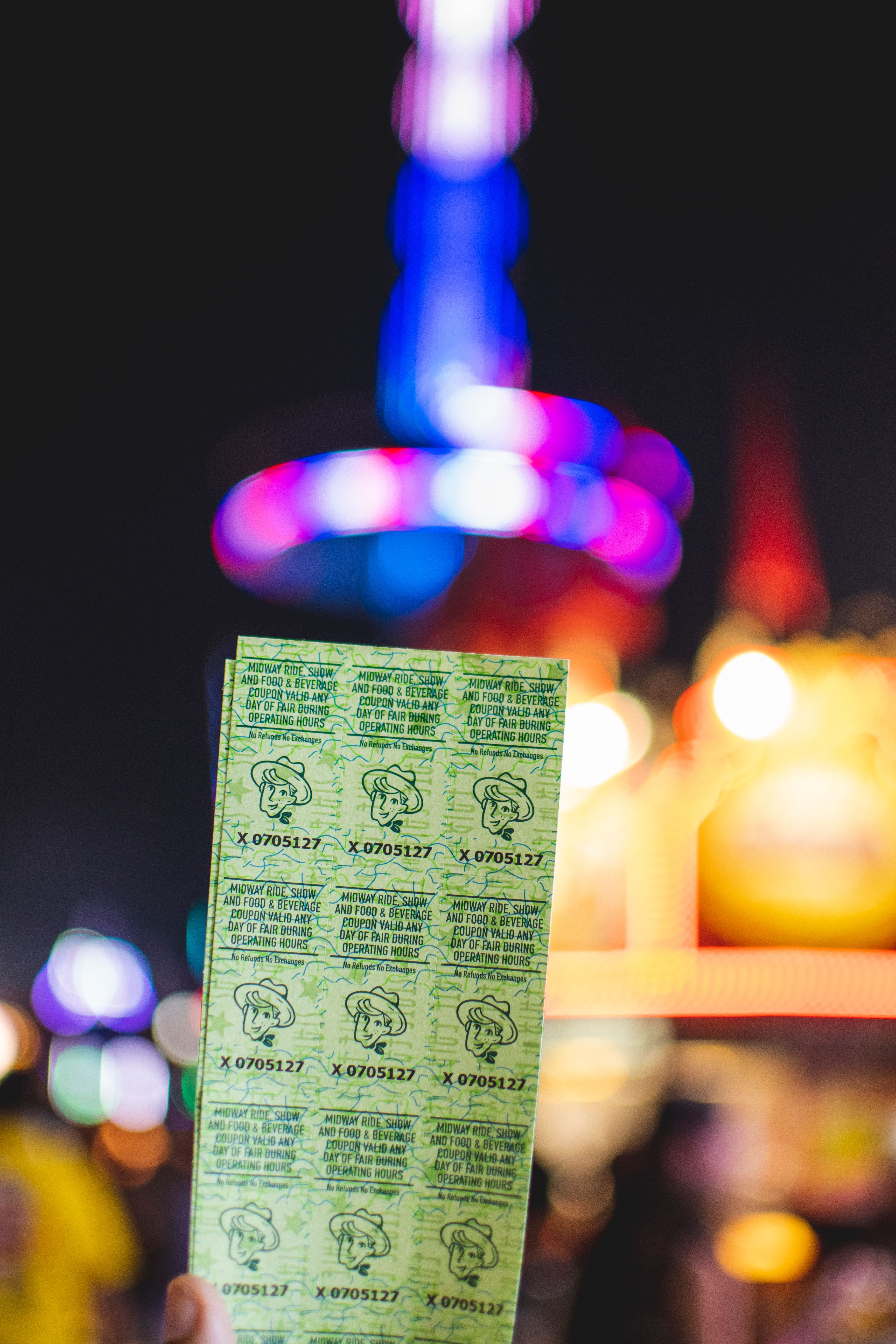 Vibrant Carnival Night with Colorful Tickets · Free Stock Photo