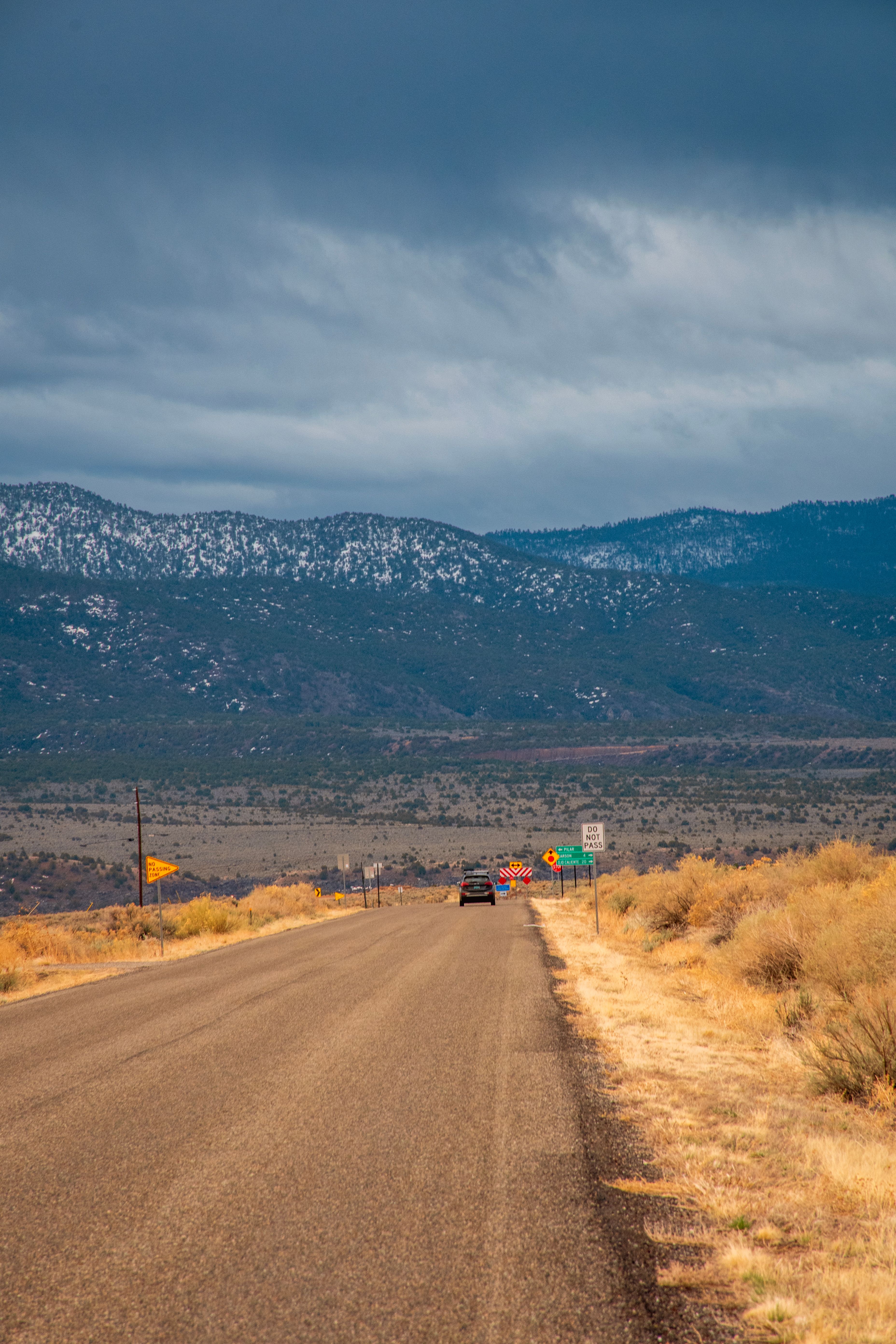Desolate Desert Highway Leading to Snowy Mountains · Free Stock Photo