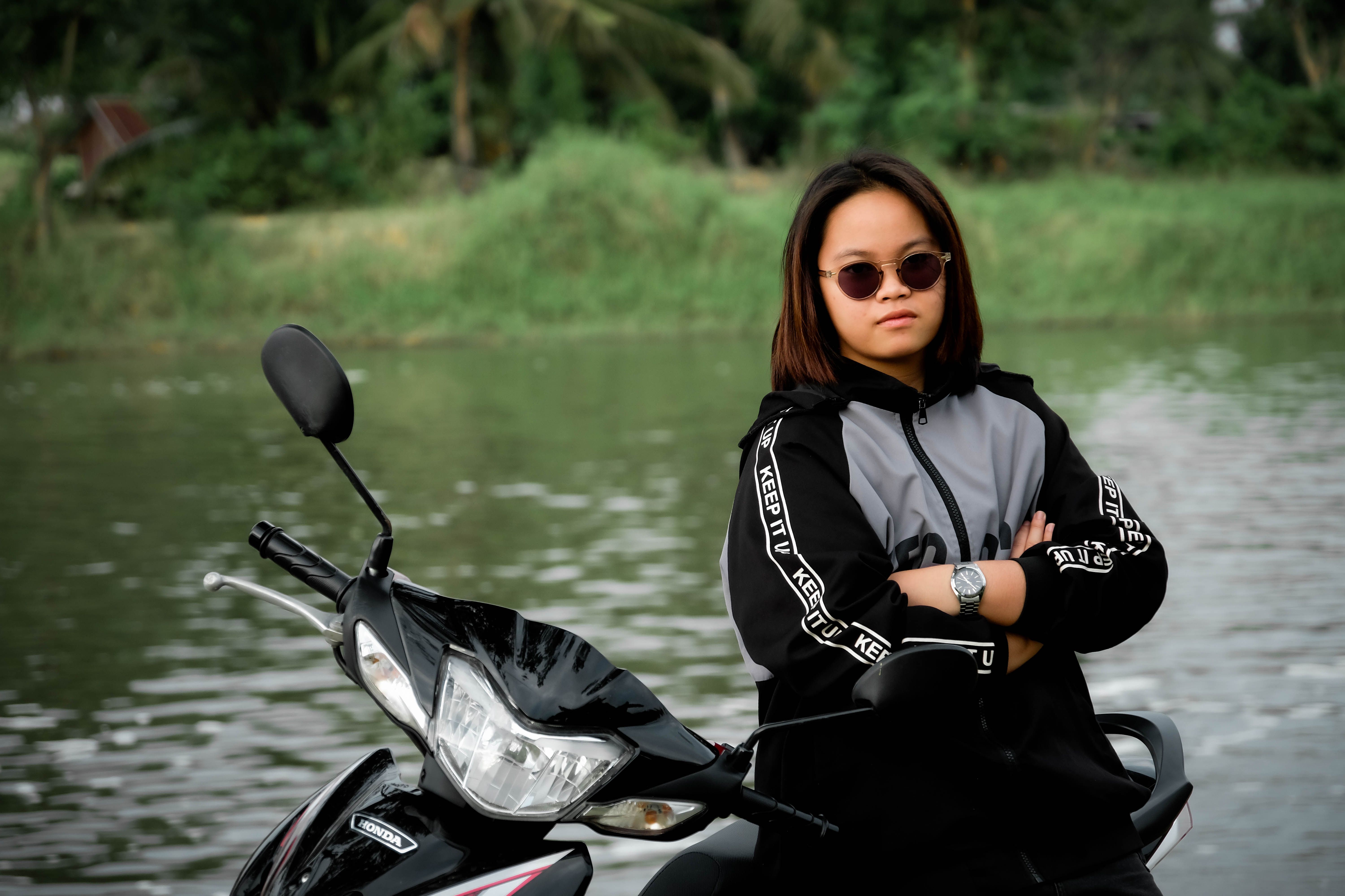 Young Woman Posing on Motorcycle by Riverside · Free Stock Photo