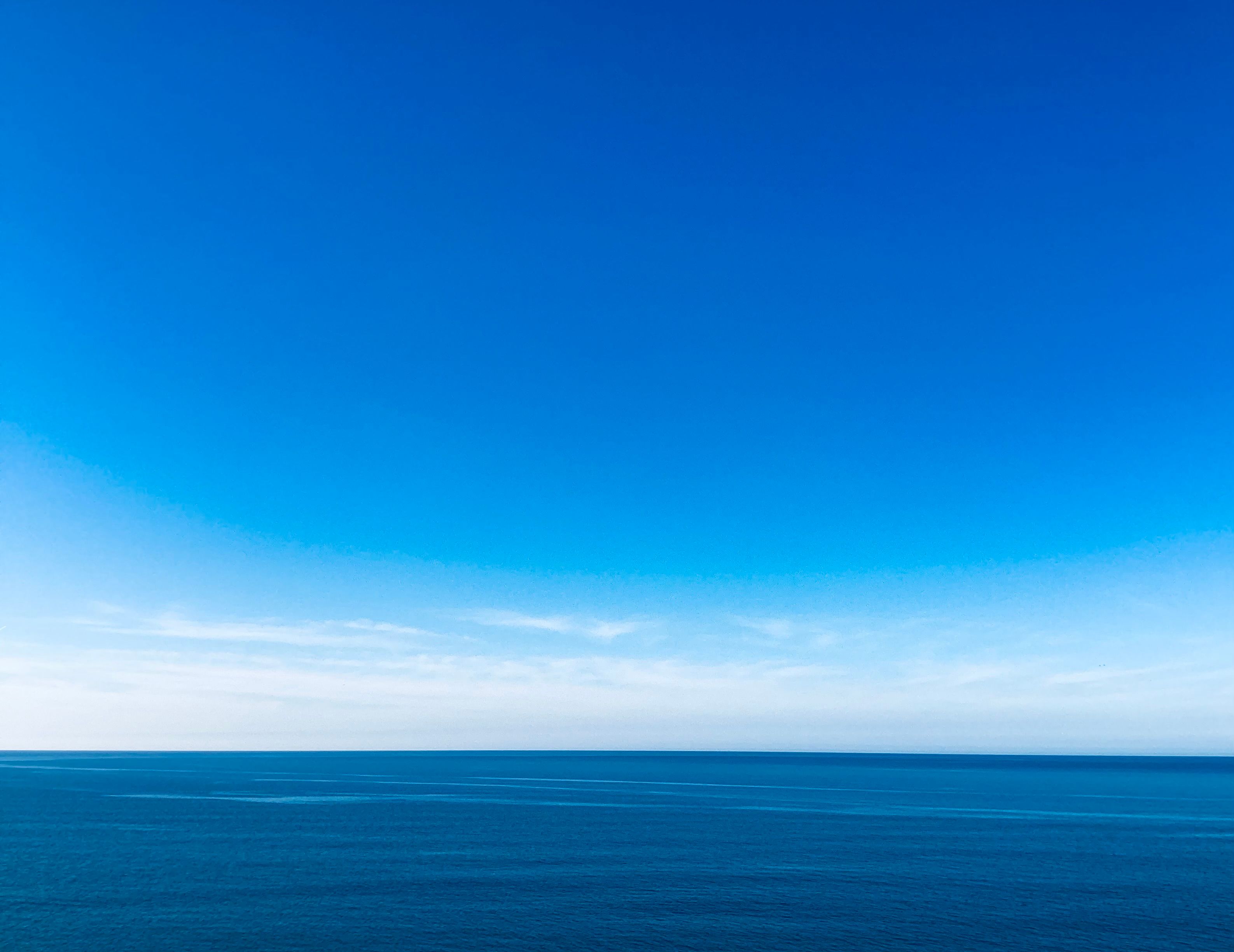 Tranquil Ocean View Under Clear Blue Sky · Free Stock Photo