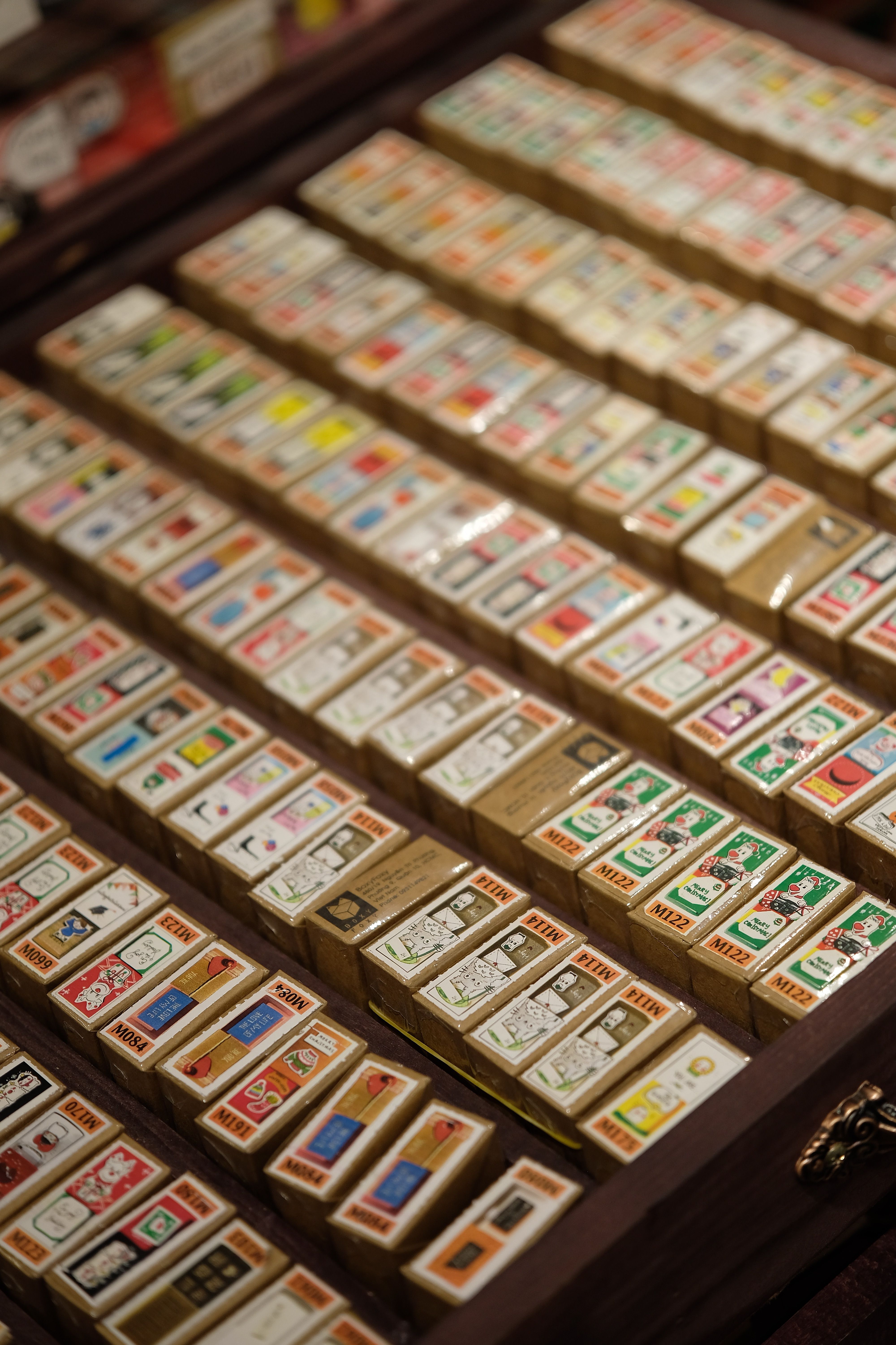 Vintage Matchbox Collection Displayed in Rows · Free Stock Photo