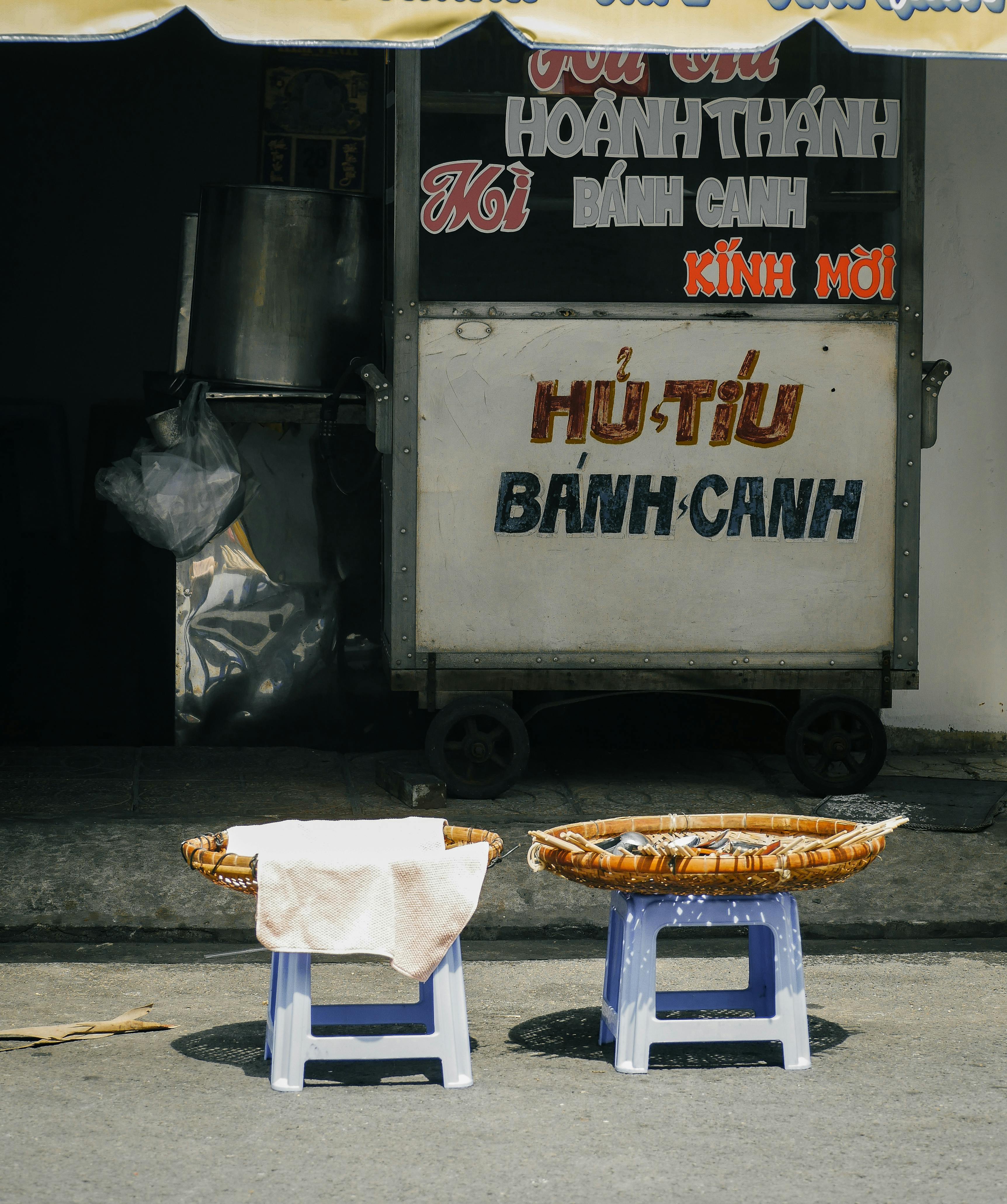 Street Food Scene with Basket and Stool in Vietnam · Free Stock Photo