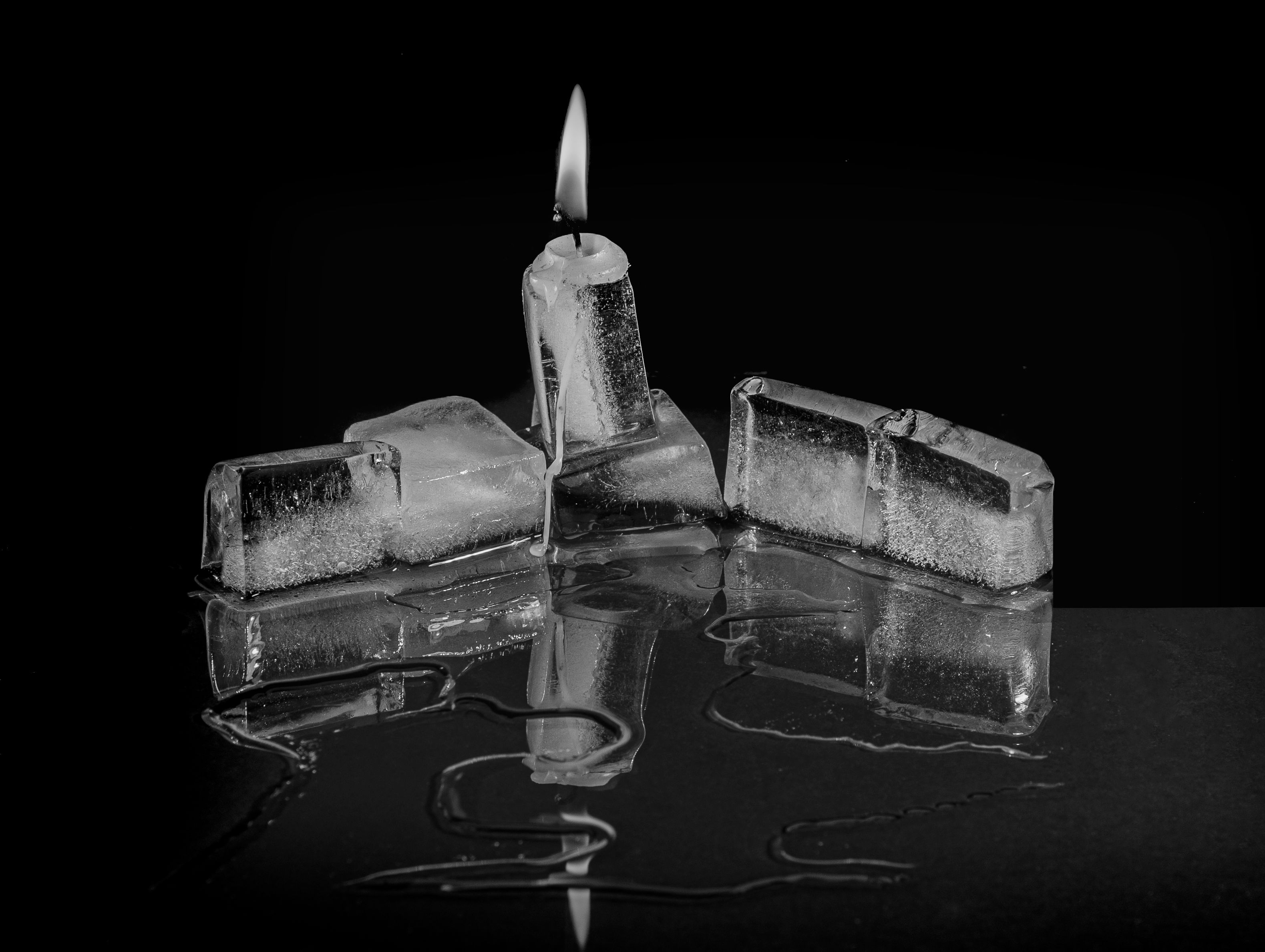 Melting Ice Candle in Dramatic Black and White · Free Stock Photo