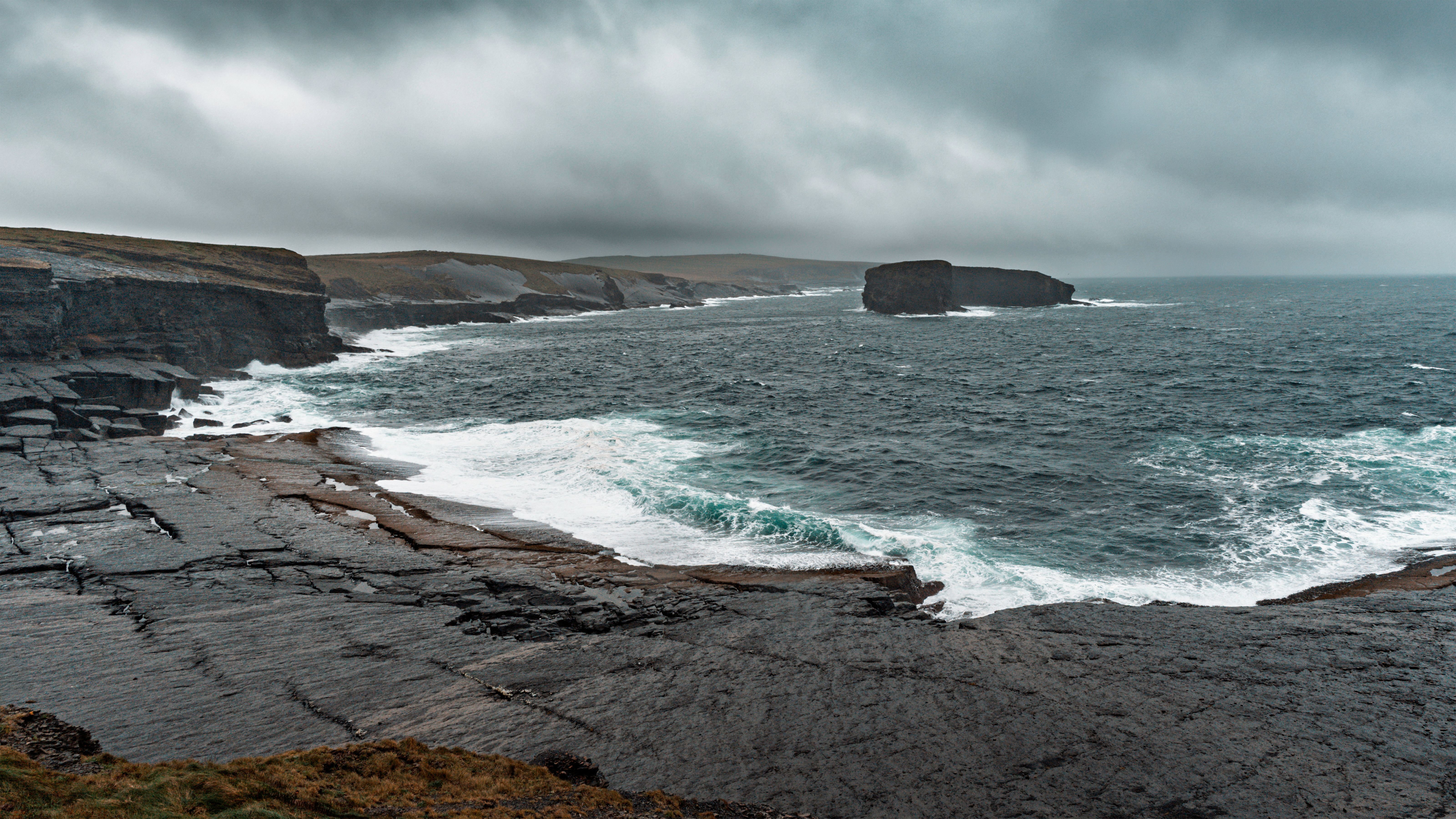 Dramatic Irish Coastal Cliffs Under Stormy Skies · Free Stock Photo
