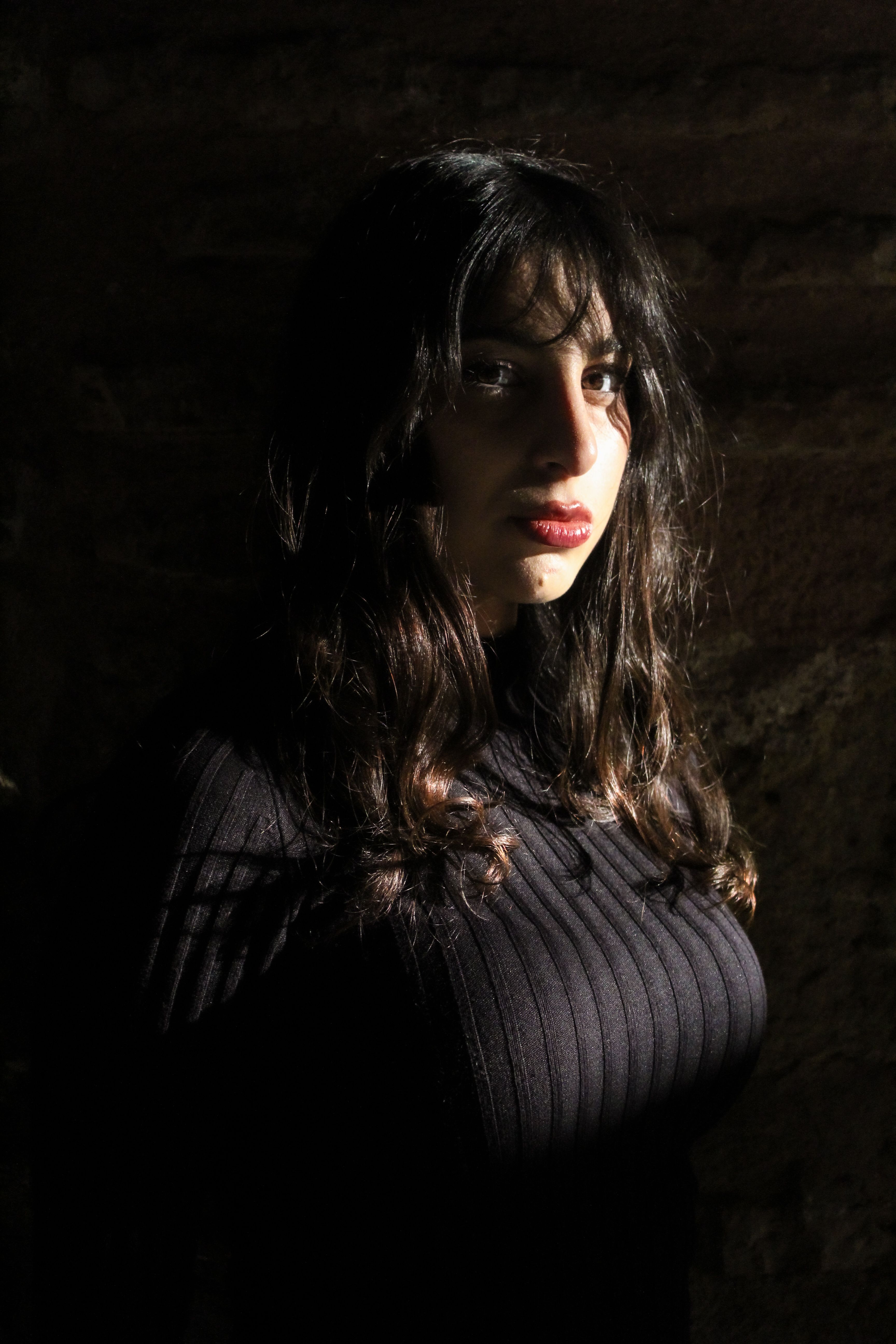 Moody Portrait of a Woman in Dramatic Lighting · Free Stock Photo