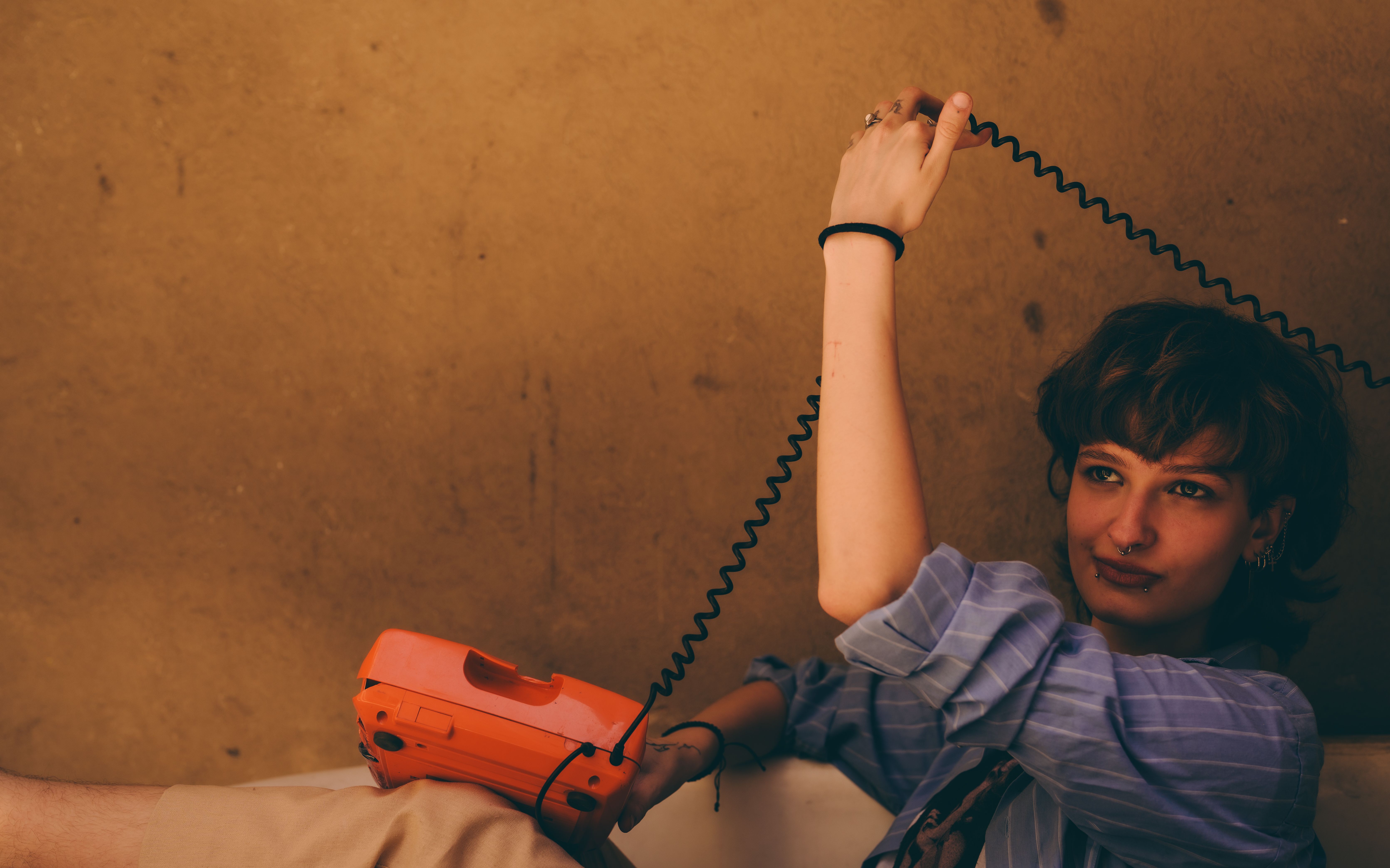Vintage Style Portrait with Orange Retro Phone · Free Stock Photo