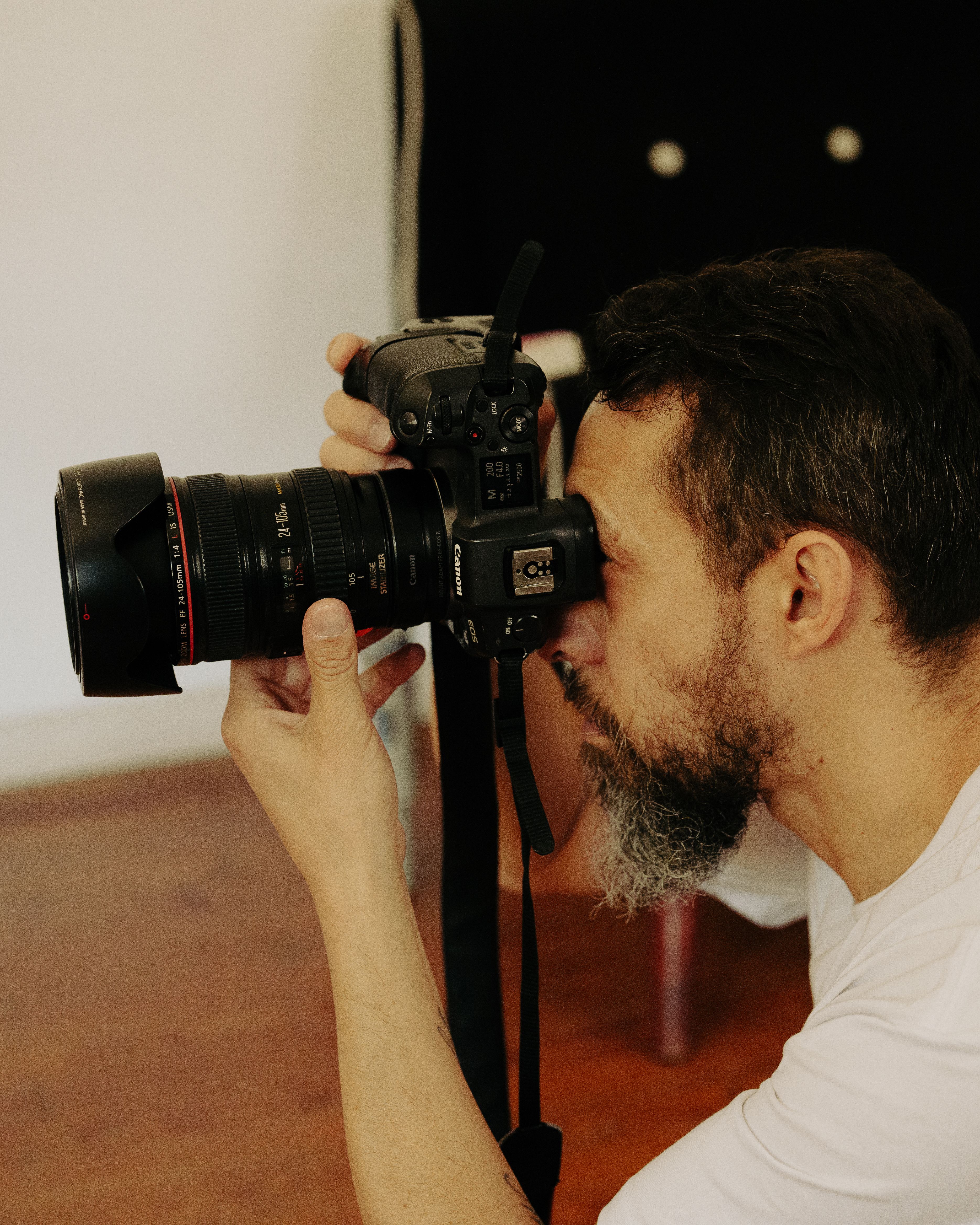 Professional Photographer Capturing Indoor Portrait · Free Stock Photo