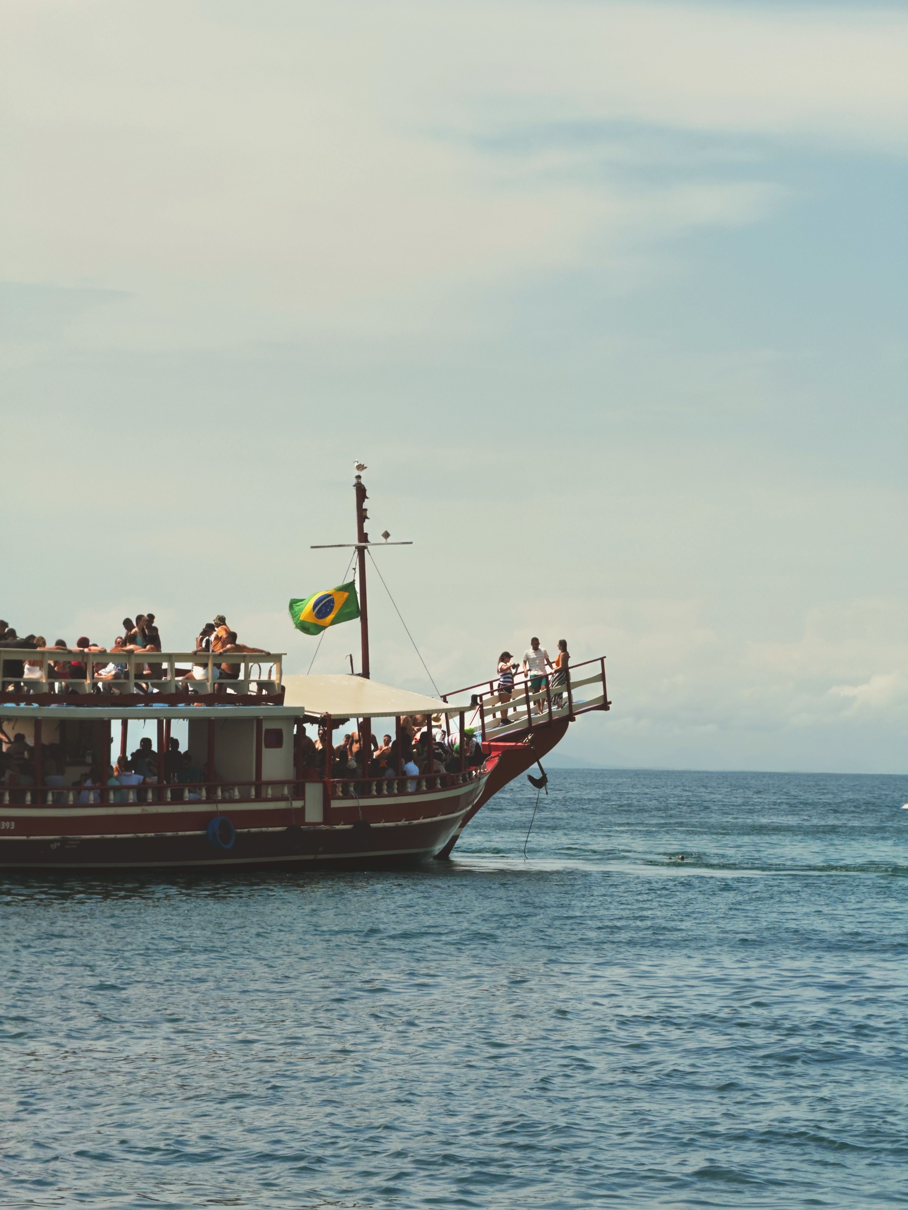 Tour Boat on Ocean with Brazilian Flag · Free Stock Photo