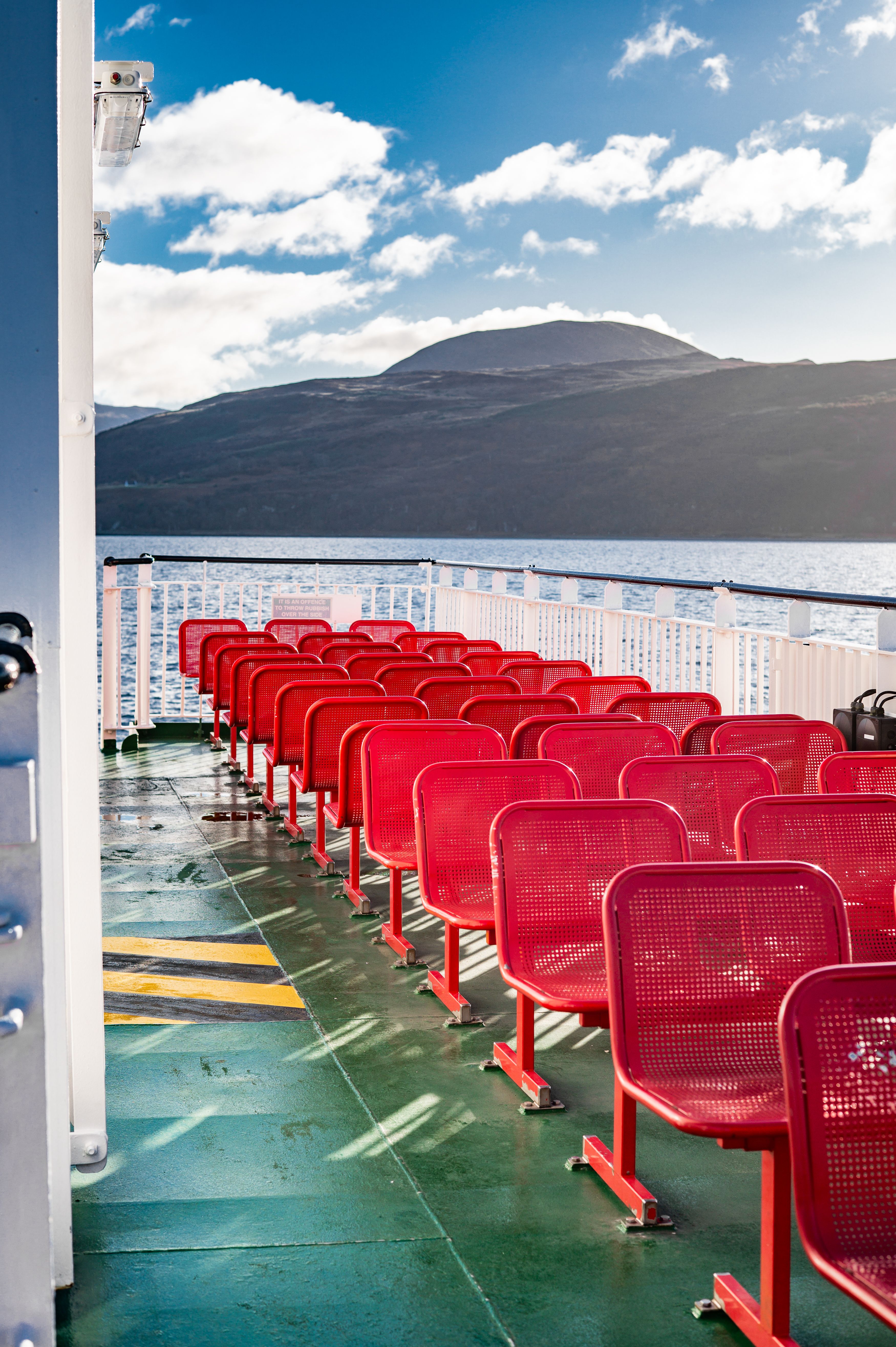 Vibrant Red Seats on Scottish Ferry in Sunlight · Free Stock Photo