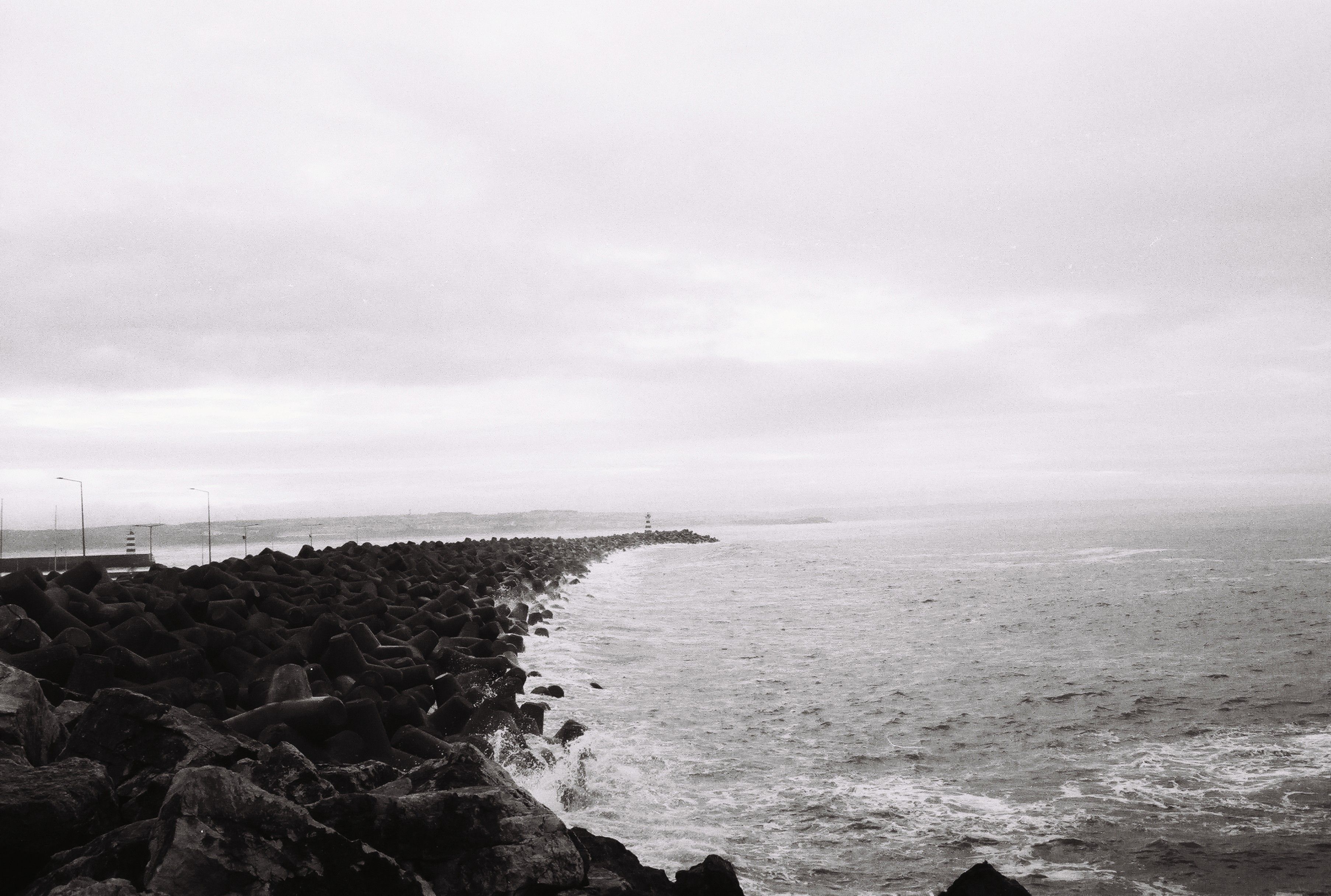 Black and White Seascape with Rock Jetty · Free Stock Photo