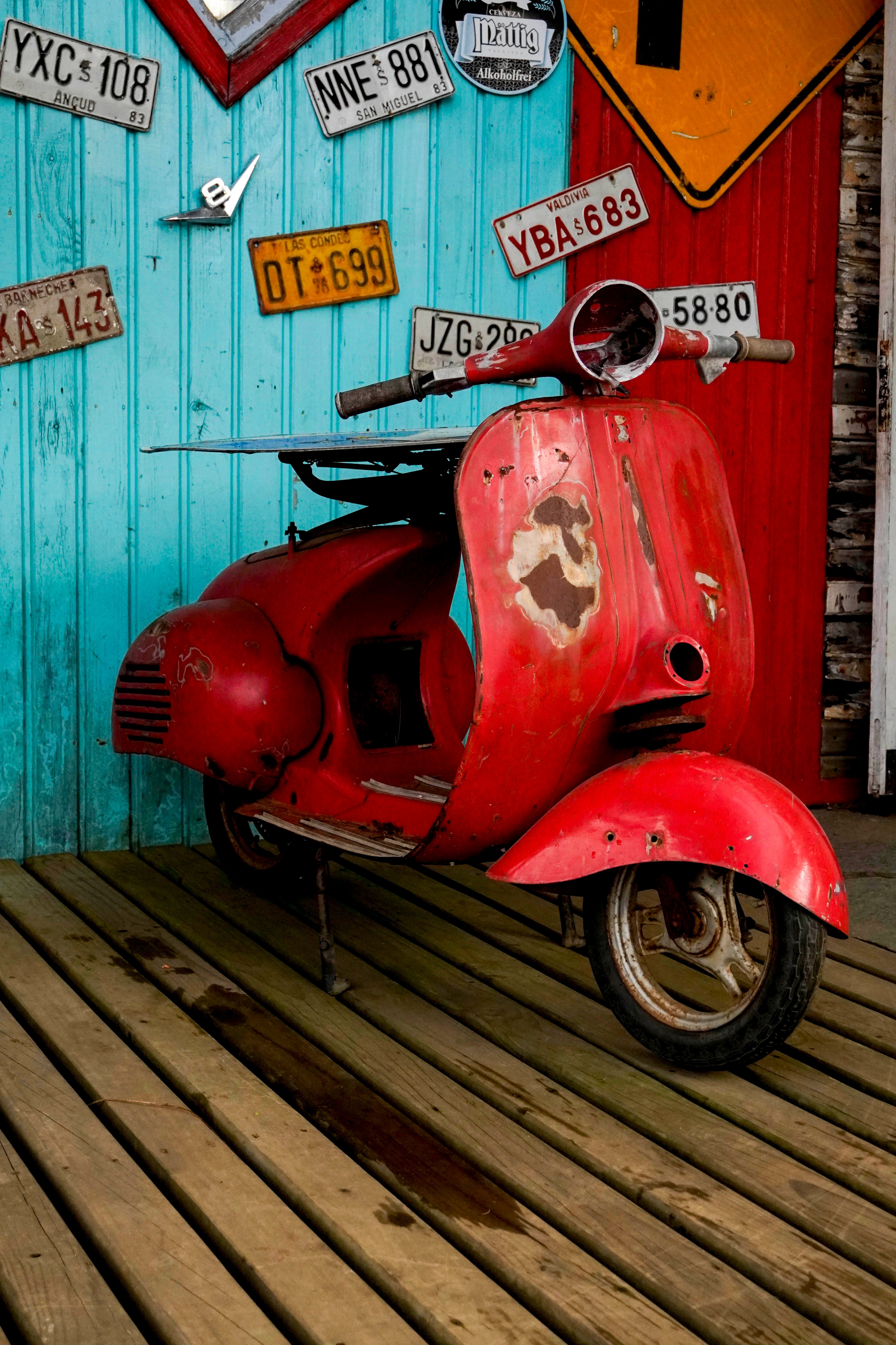 Retro Red Scooter Against Vintage License Plates · Free Stock Photo