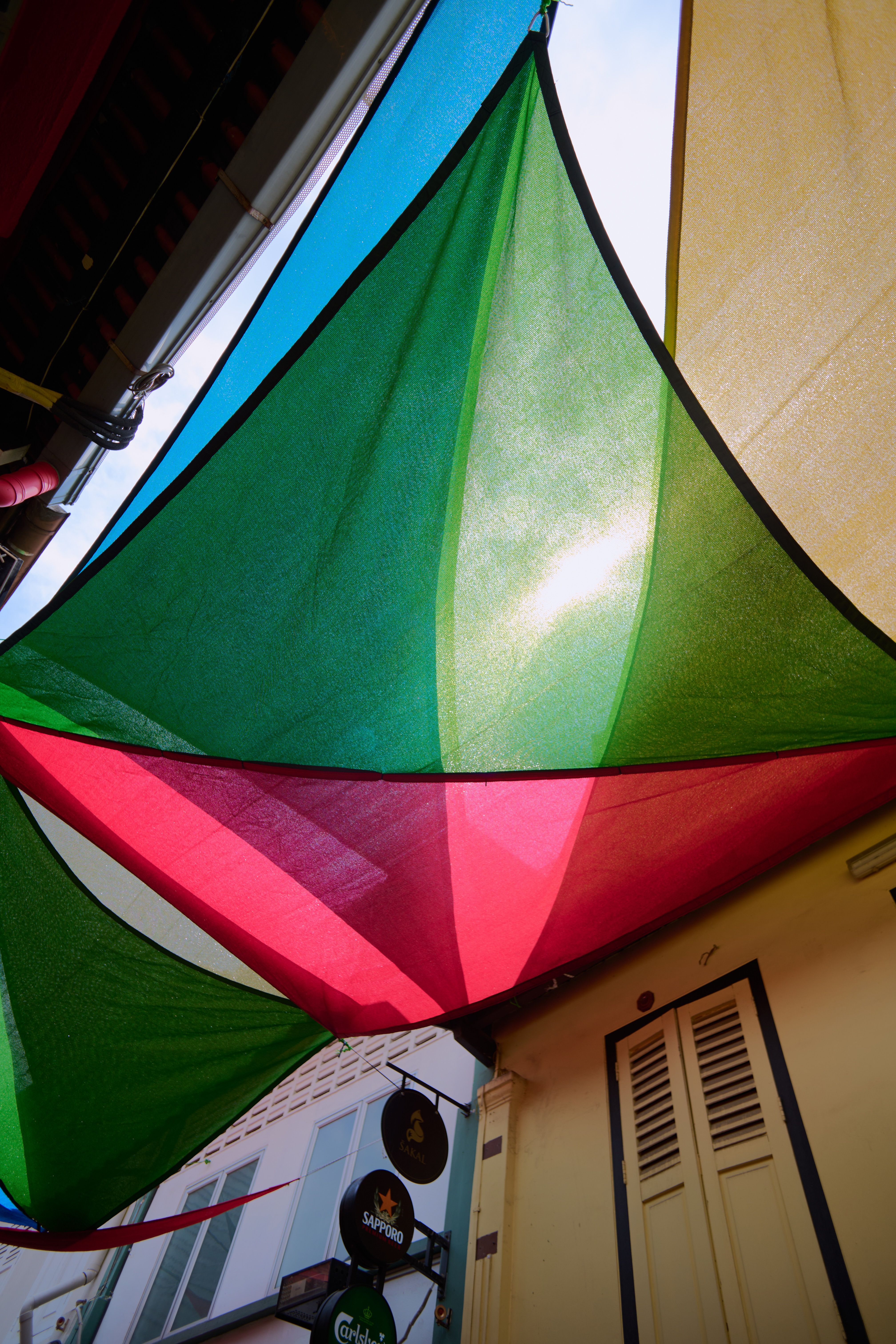 Colorful Canopies and Sunlight in Outdoor Market · Free Stock Photo