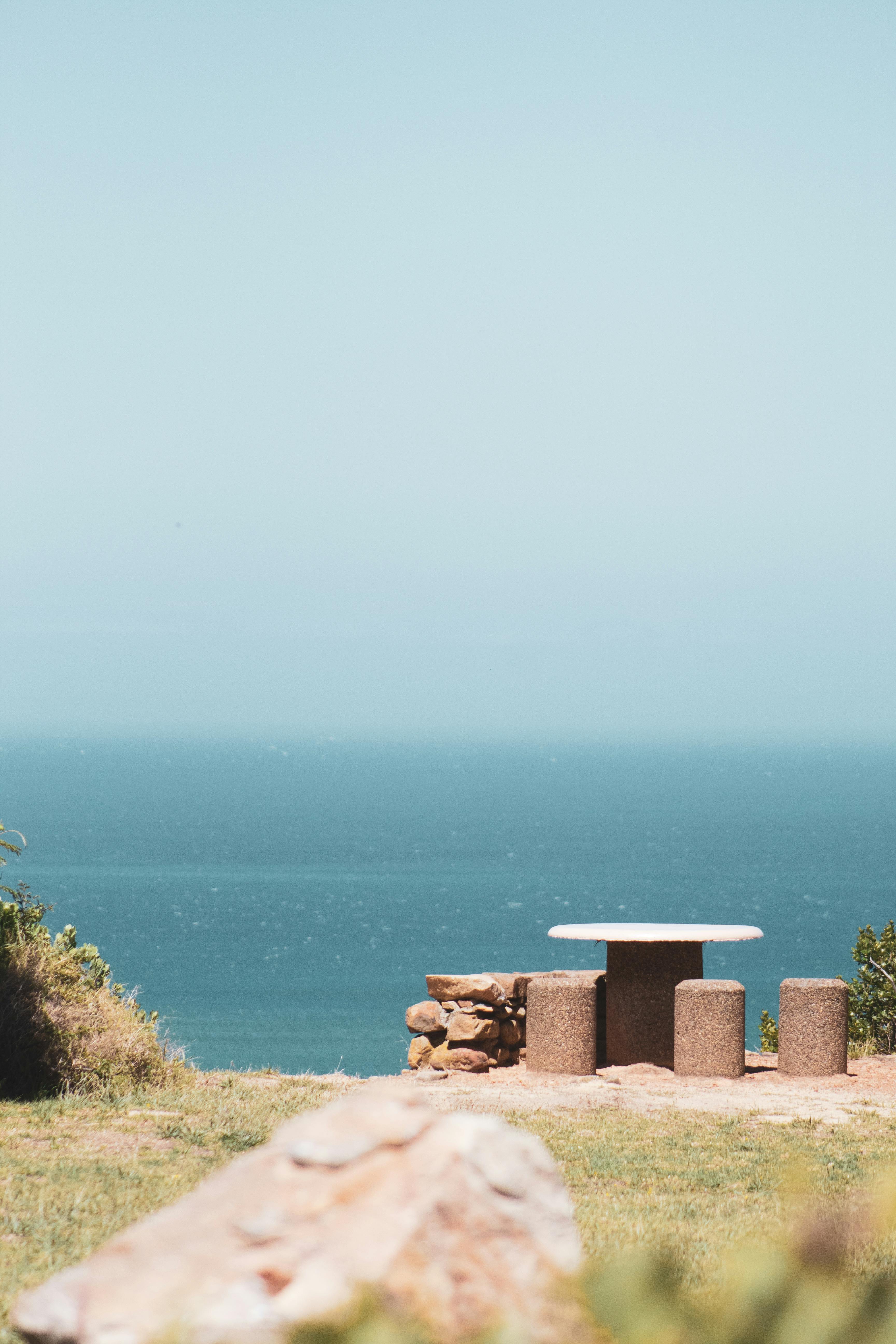 Banquet wooden table and chairs on terrace near lake · Free Stock Photo