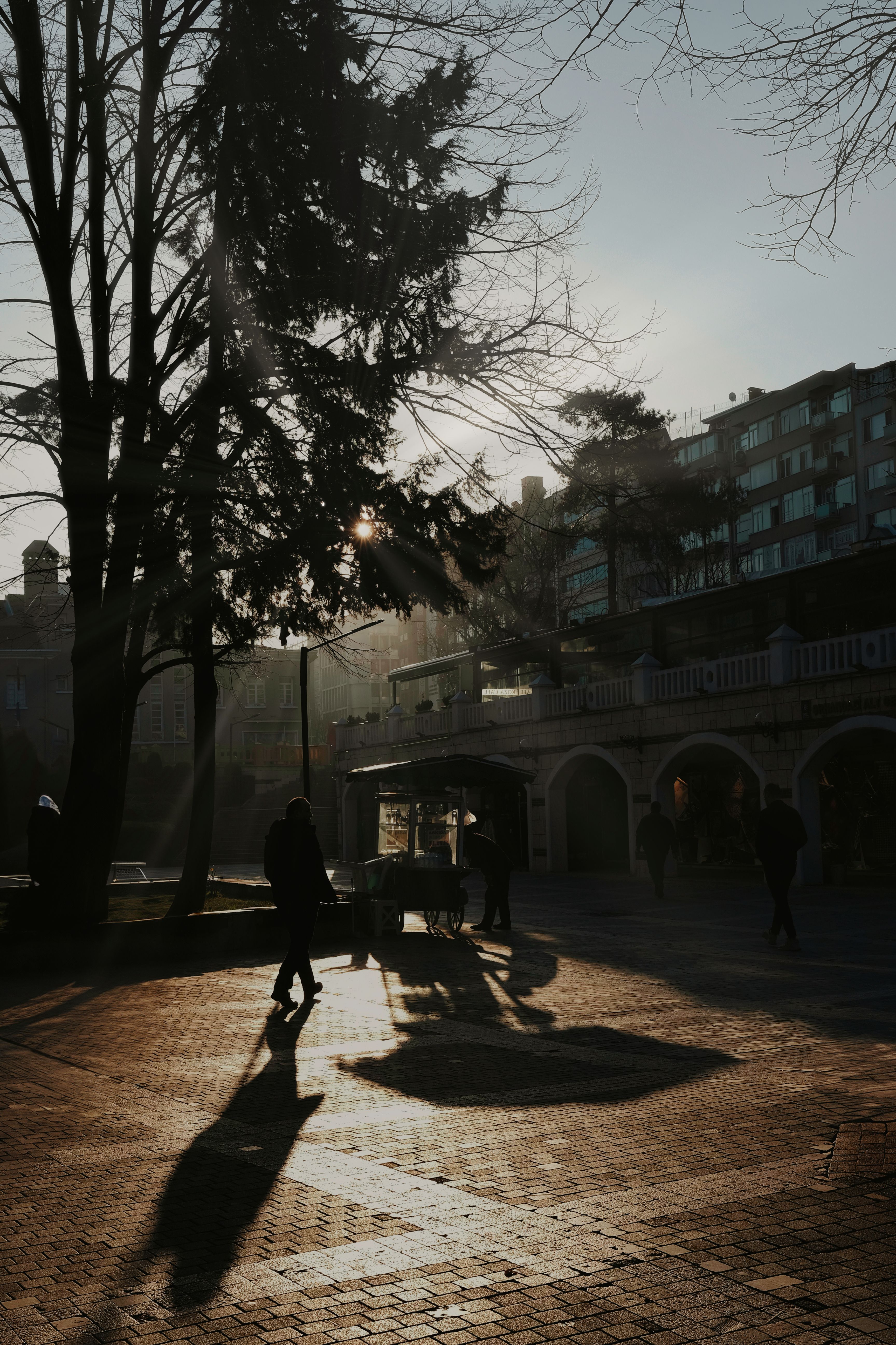 Silhouetted Figures in Bursa's Sunlit Square · Free Stock Photo