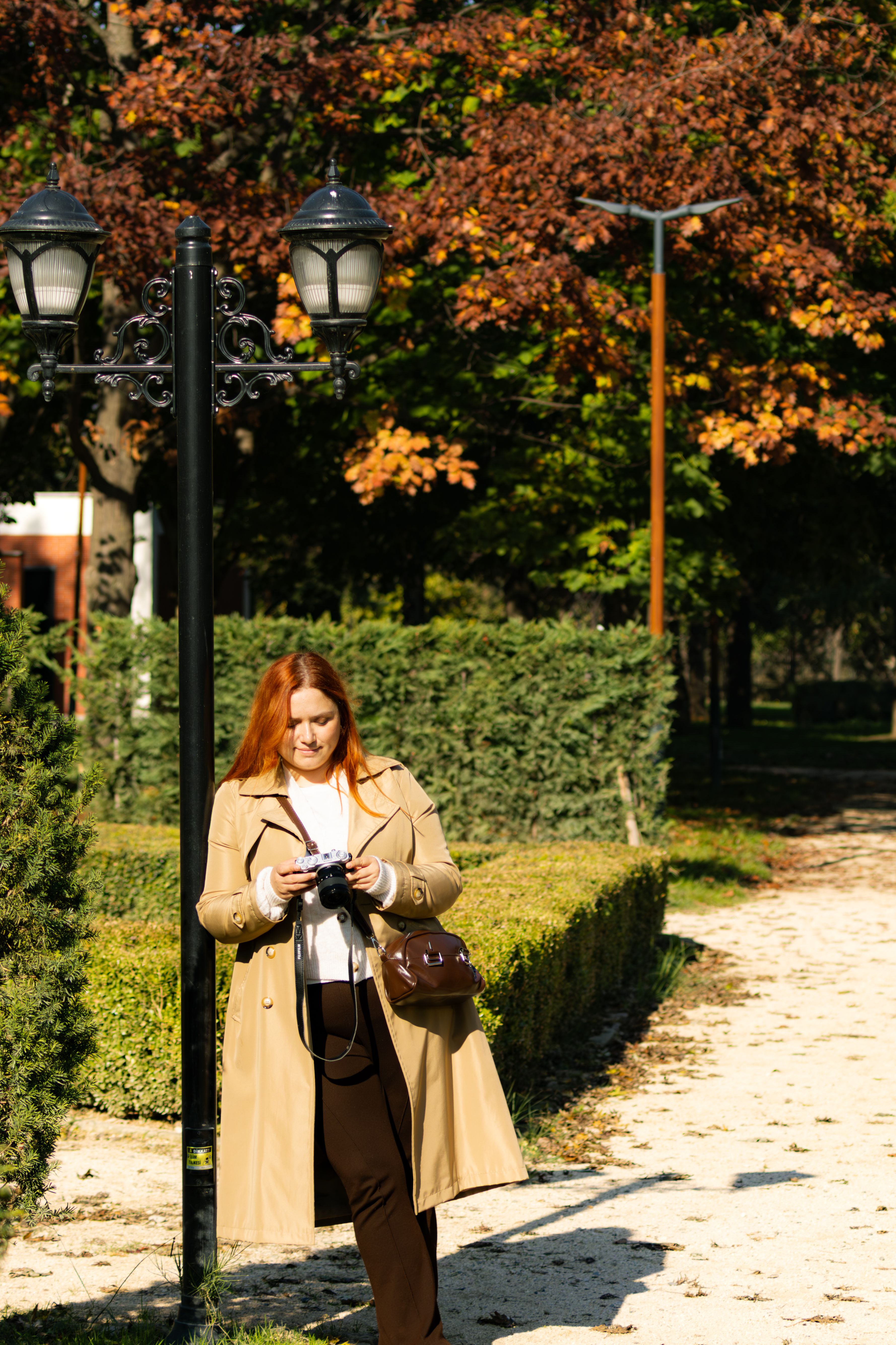 Woman in Trench Coat Standing in Autumn Park · Free Stock Photo