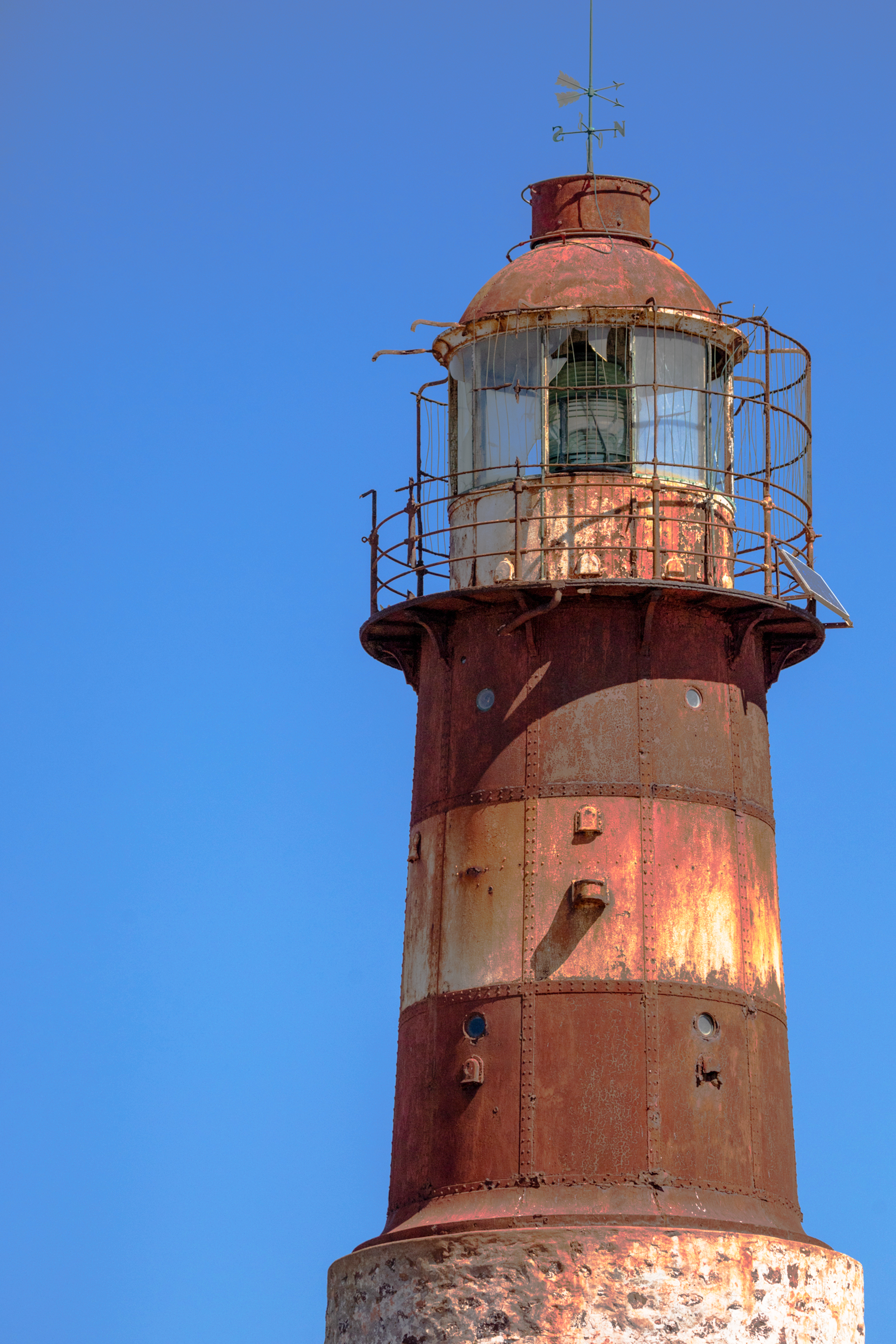 Rustic Lighthouse Tower Against Clear Blue Sky · Free Stock Photo