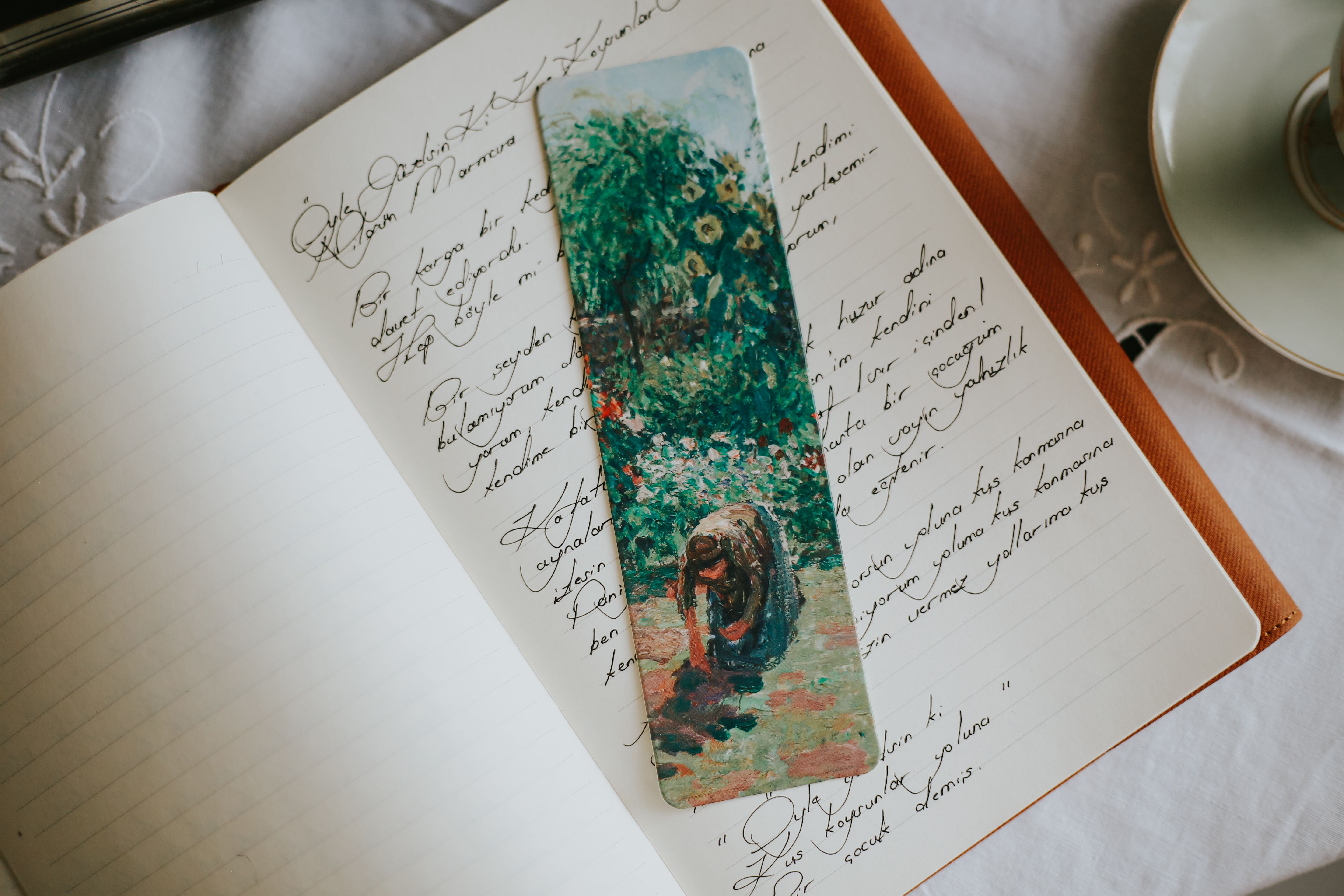 Open Journal with Painted Bookmark Insert · Free Stock Photo