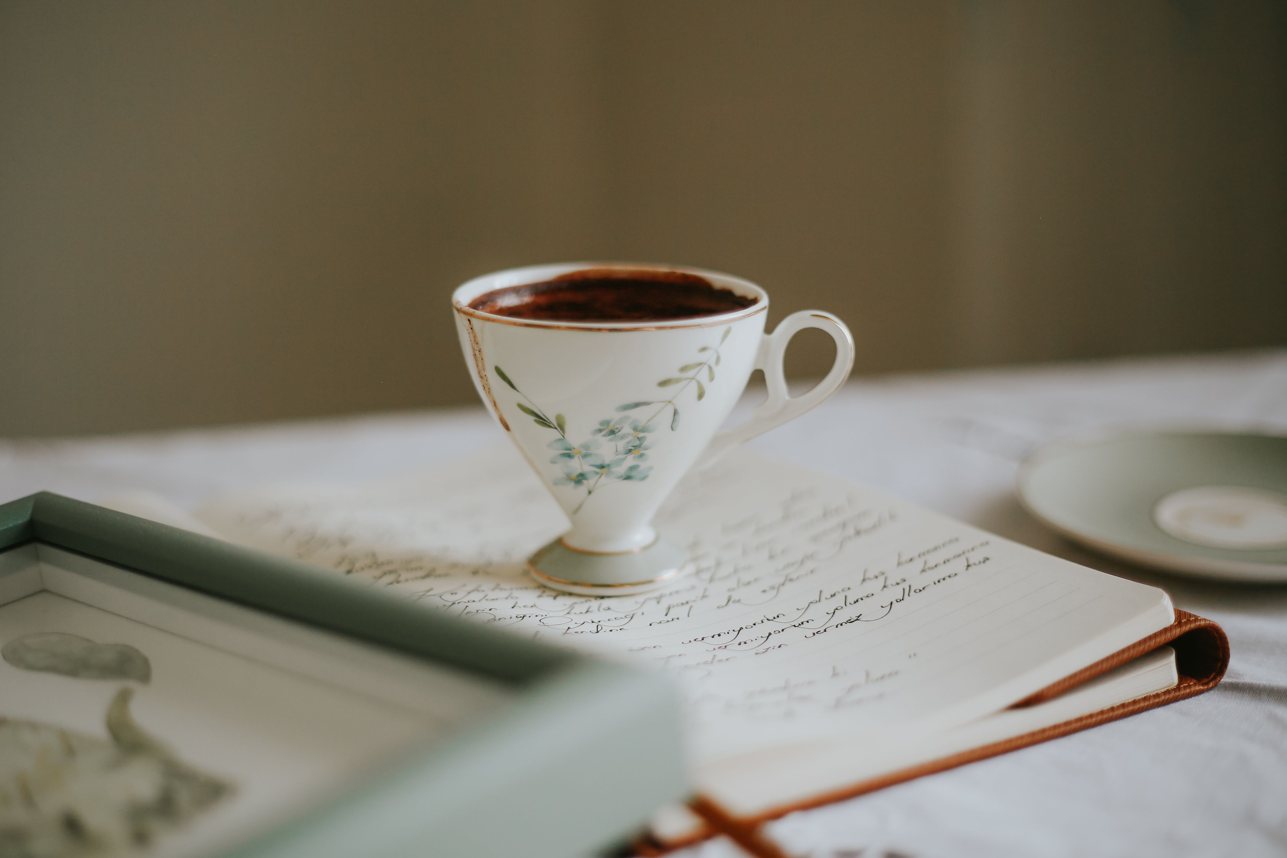 Artistic Still Life with Cup and Journal on Table · Free Stock Photo