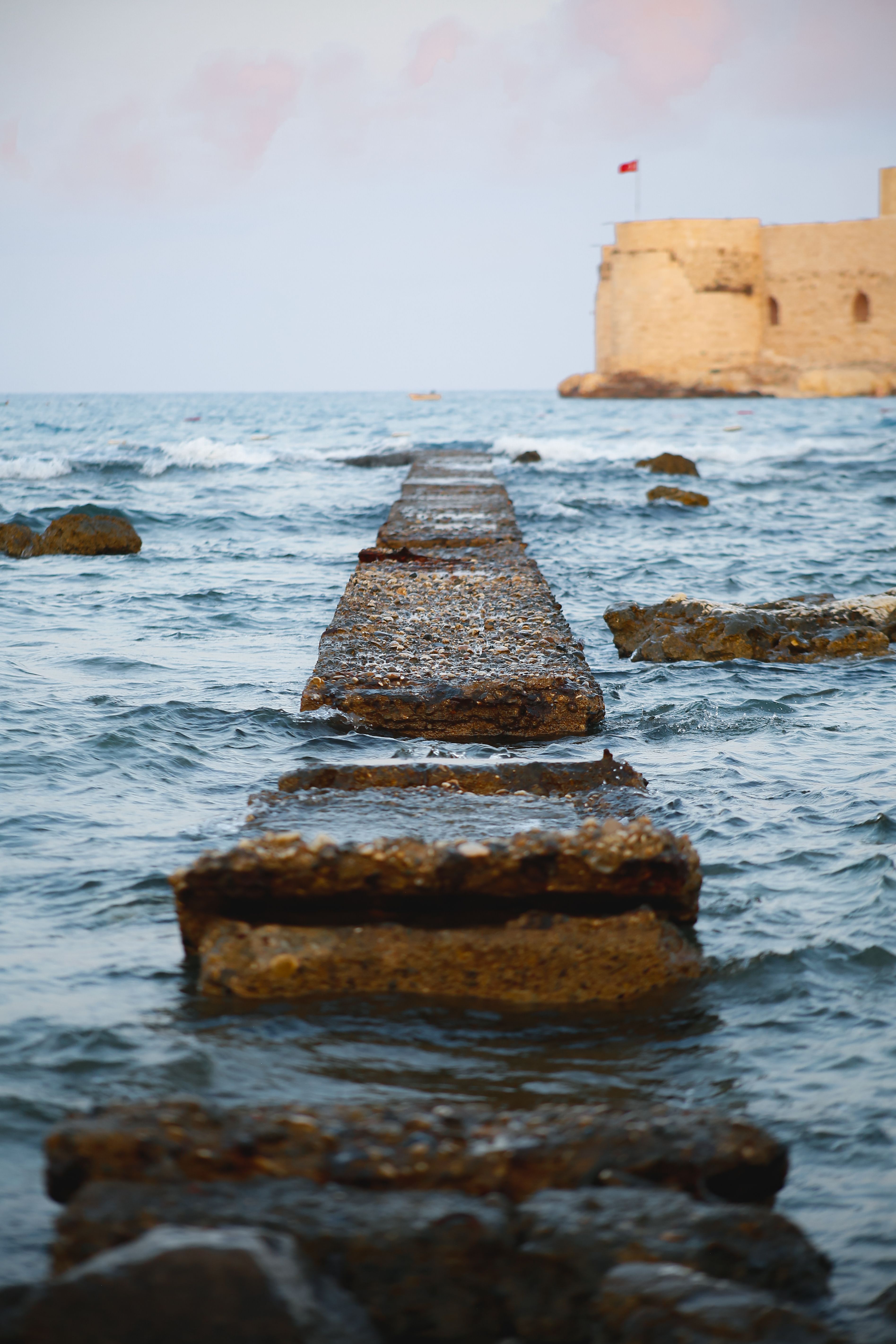 Stone Jetty Leading to a Historic Castle in the Sea · Free Stock Photo